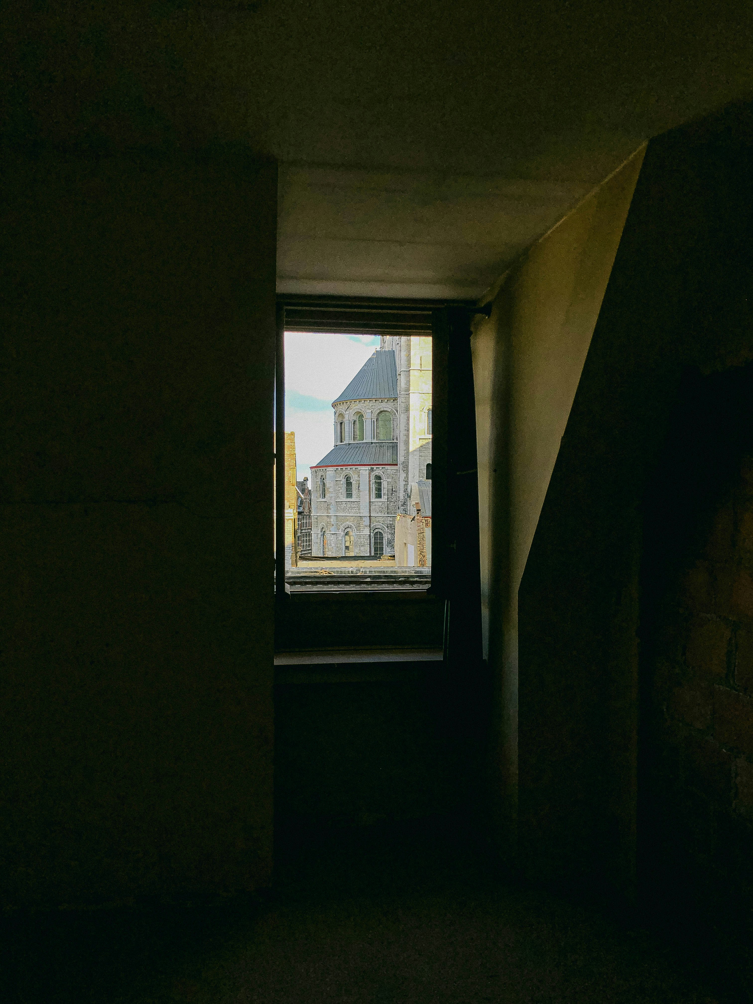 Light Pierces the Window: A Quiet Interior Framing a Cathedral View