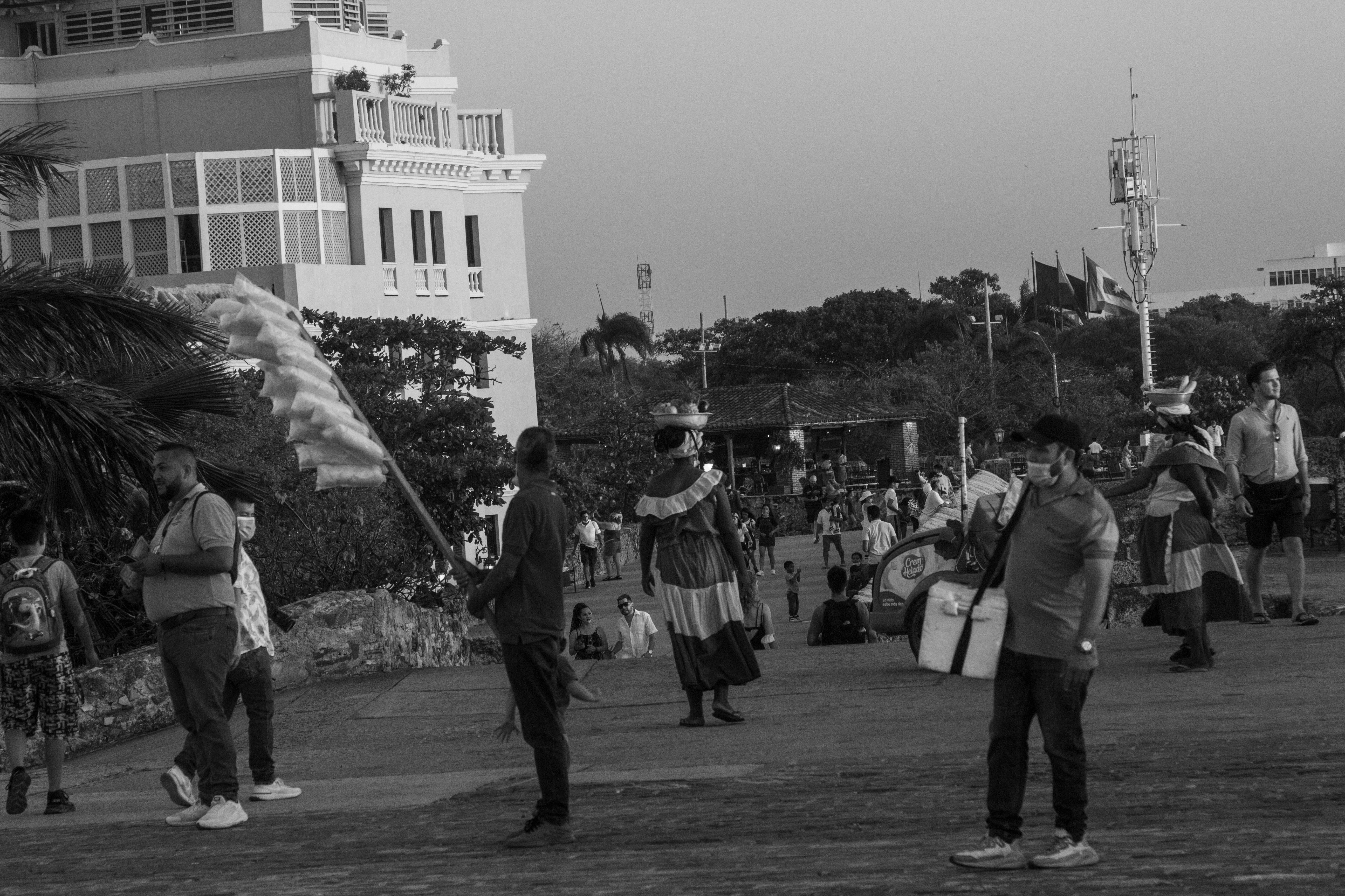 A vibrant street scene featuring performers and spectators, showcasing local traditions and community spirit during an outdoor event.