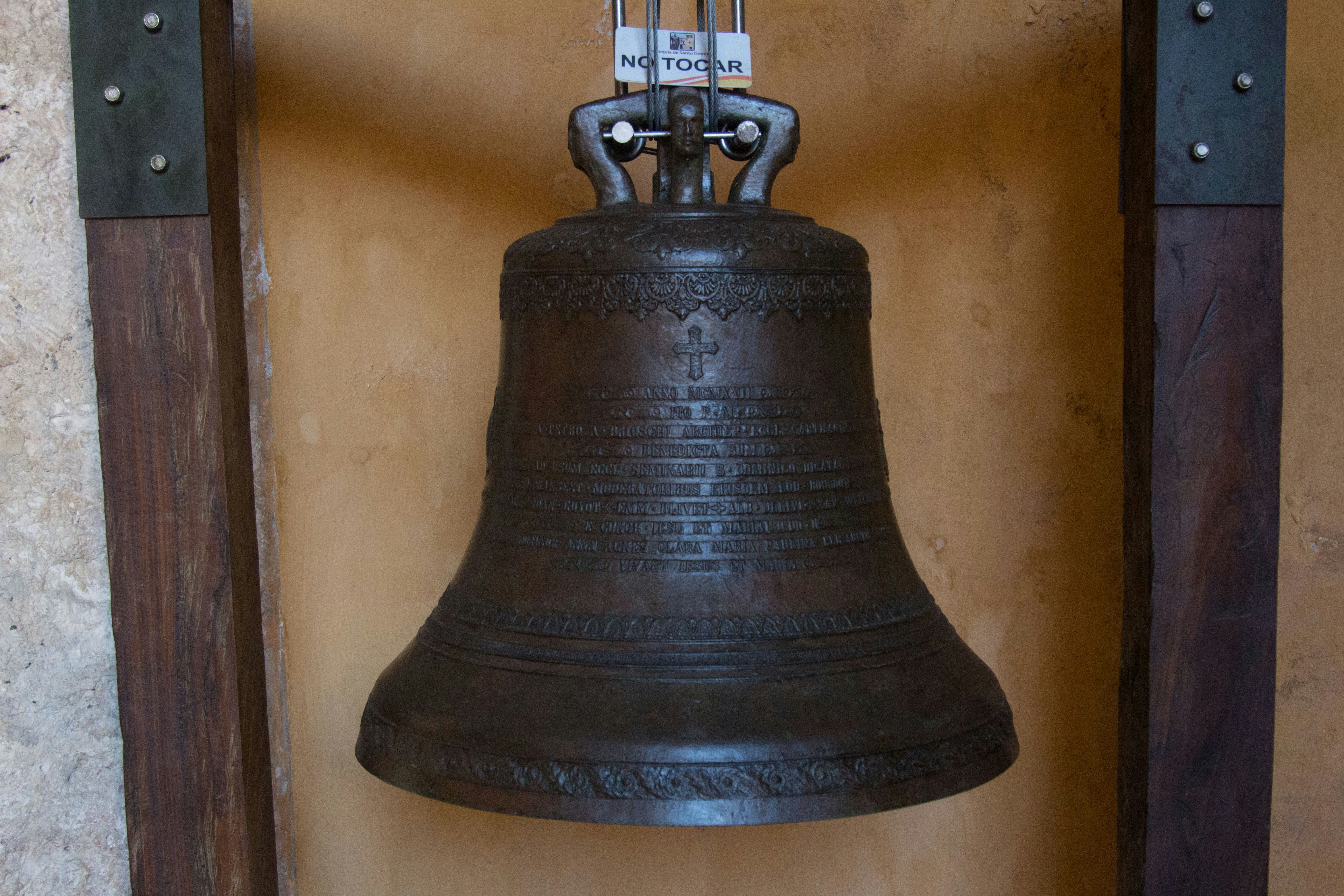 a black bell on a wall