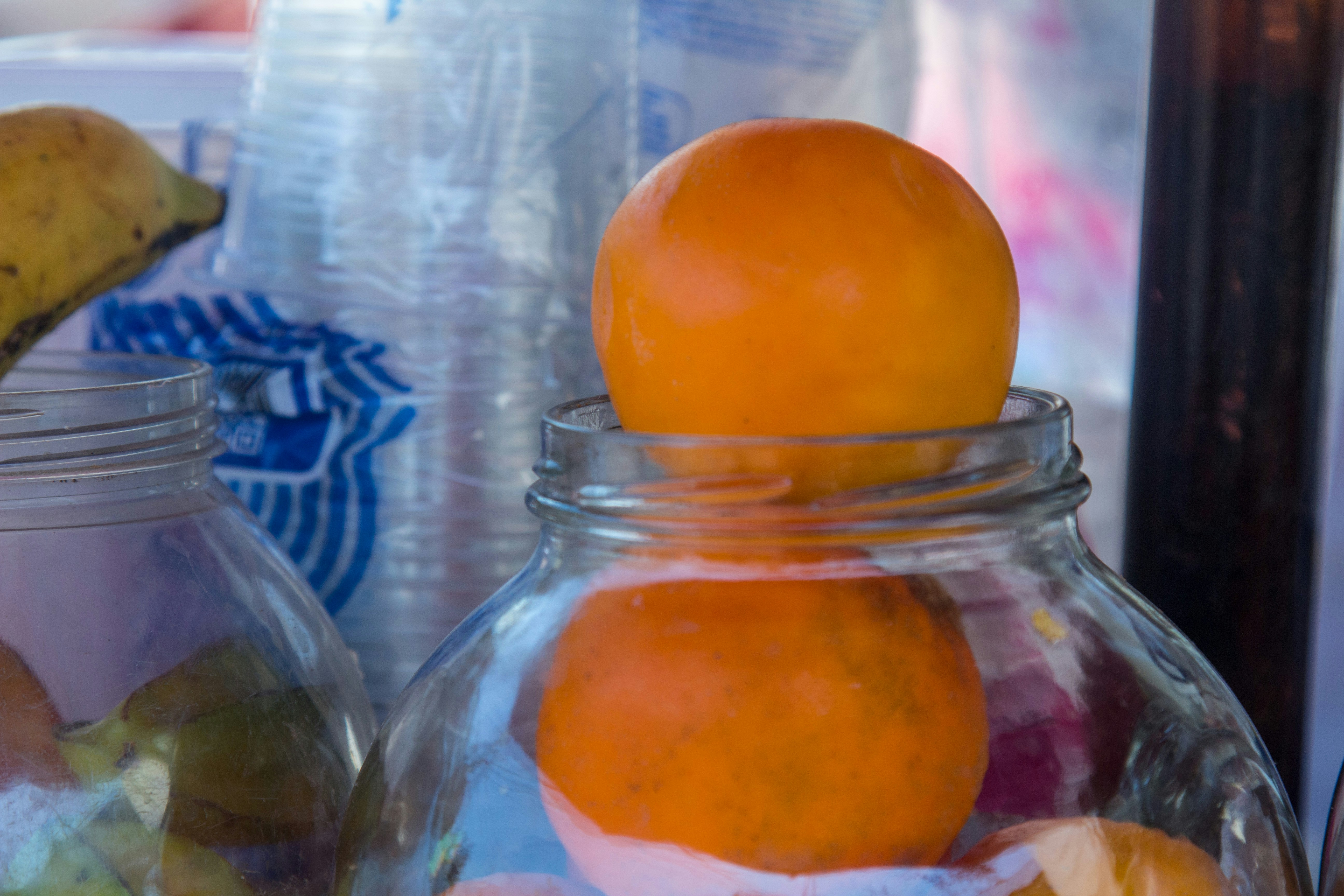a glass jar full of oranges