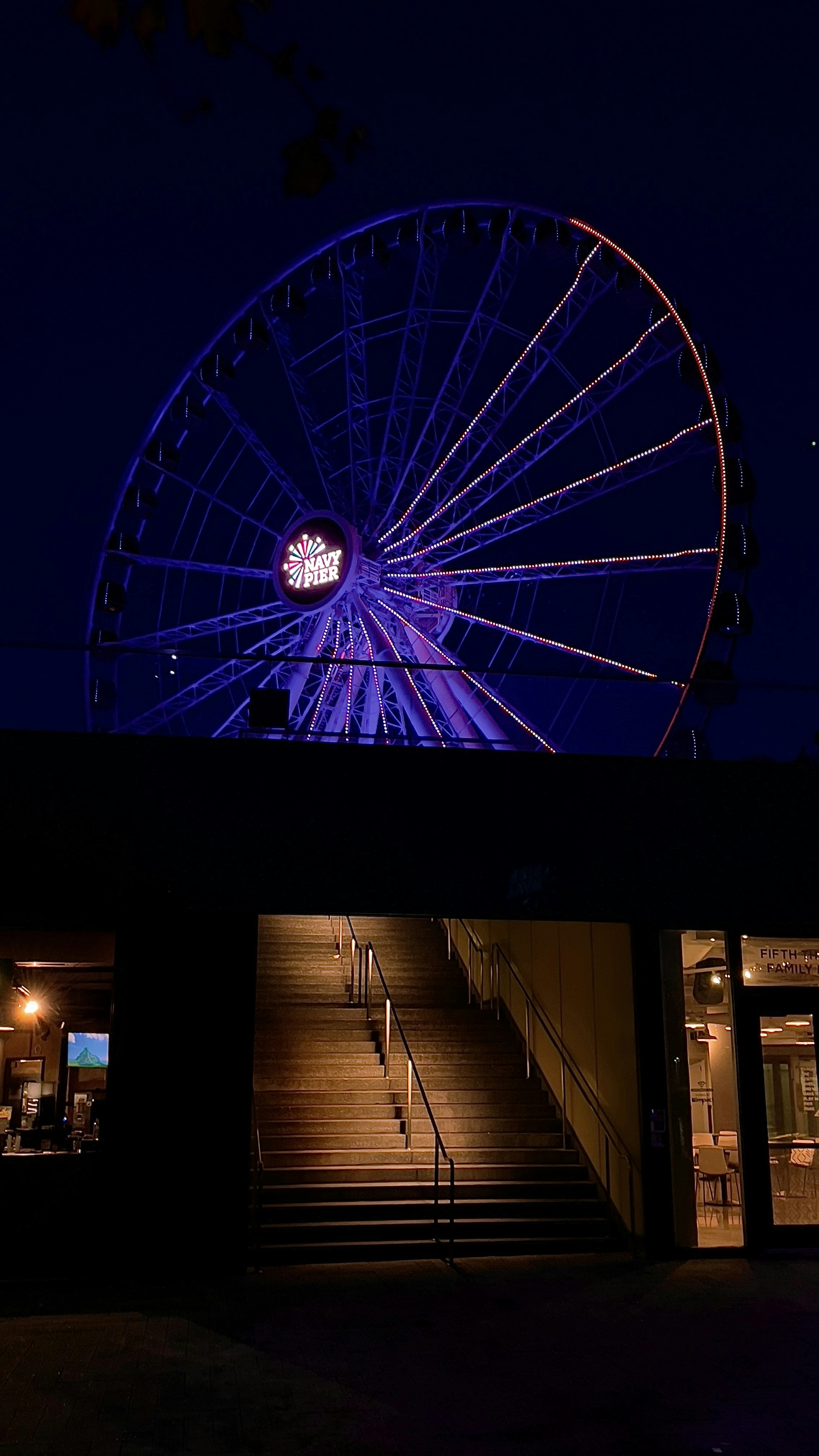 Midnight Violet Wheel: Neon Spokes Over a Quiet Pier