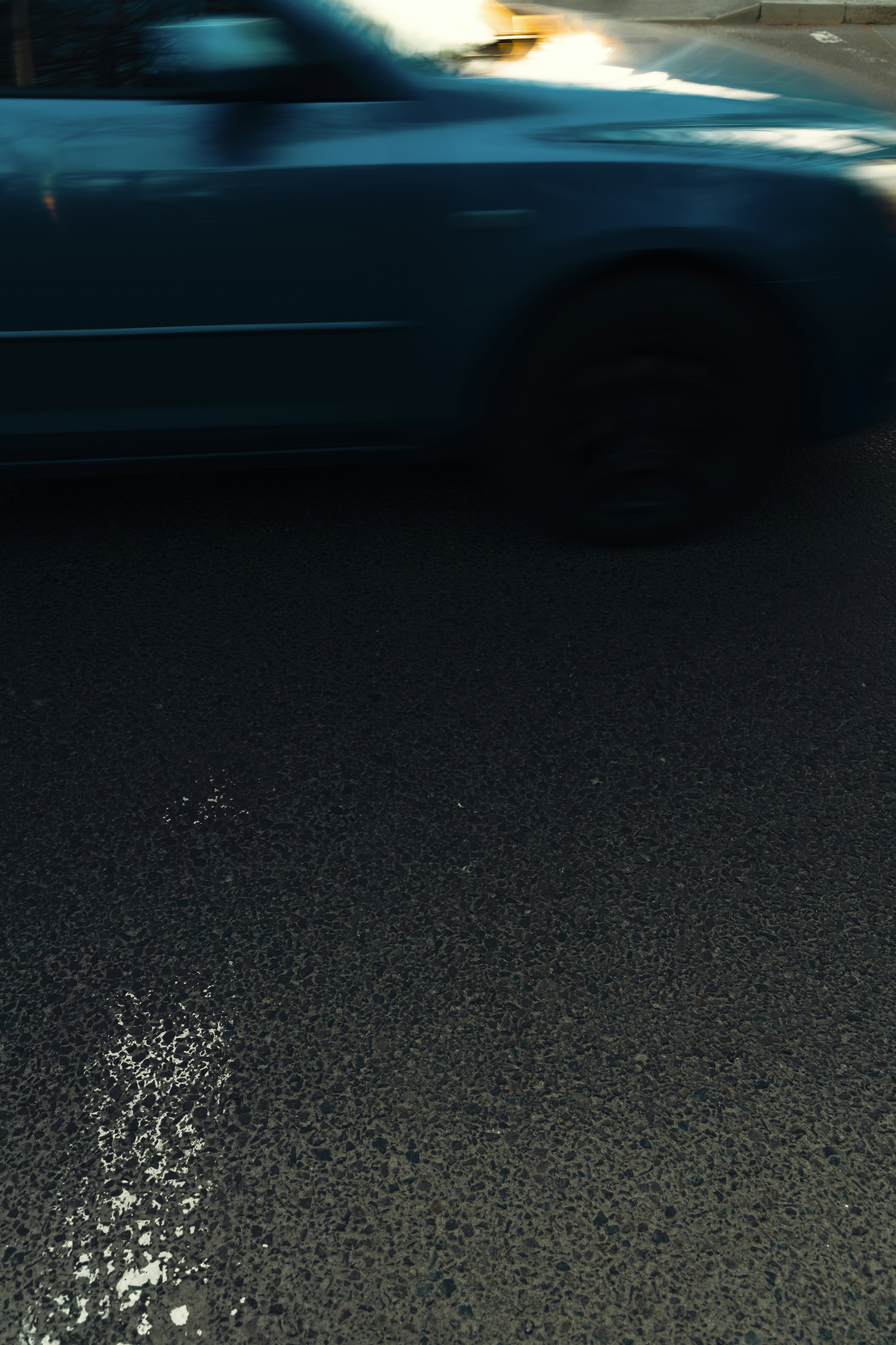 Blue Streak Across a Wet Street