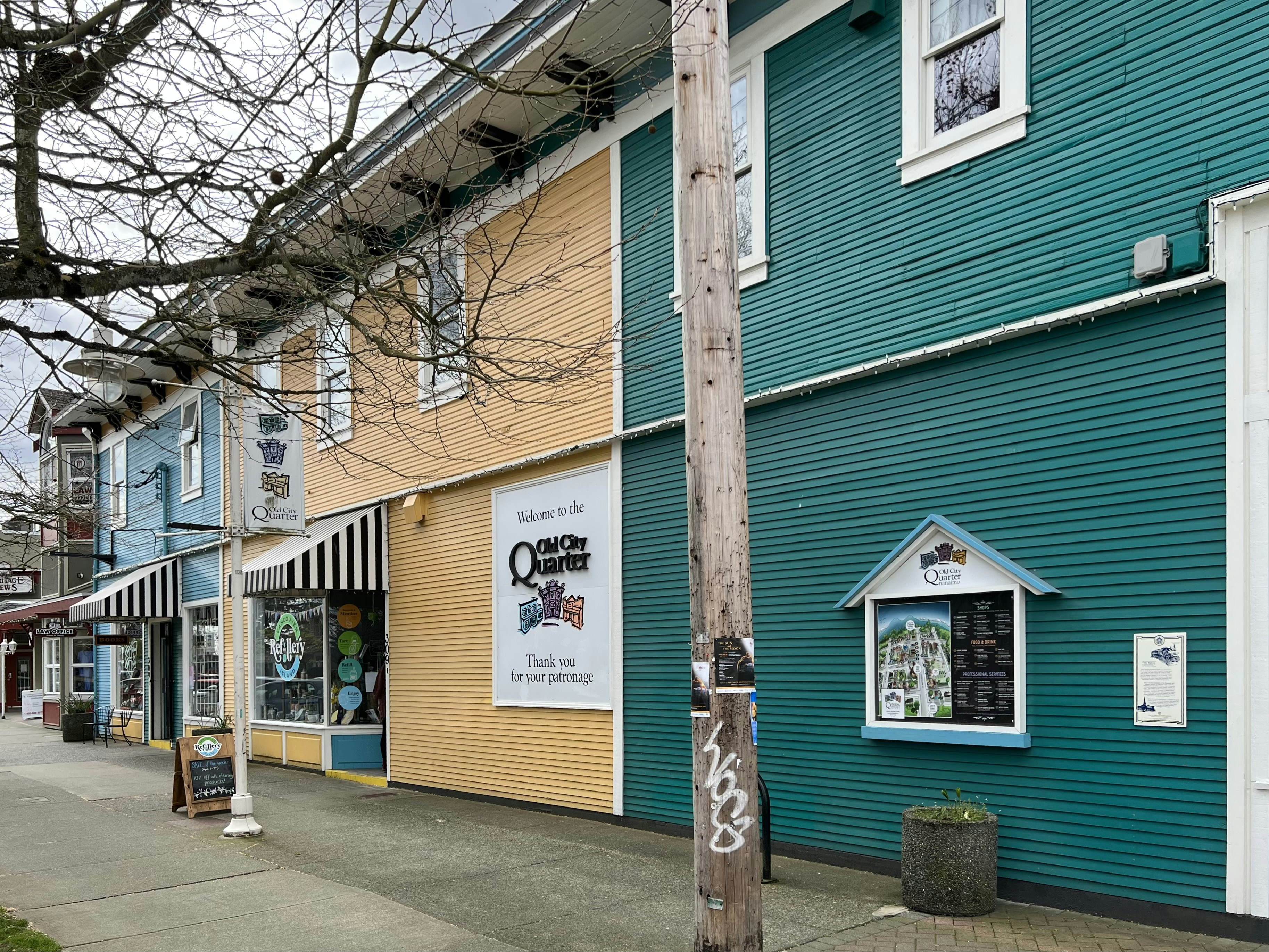 A green building with signs on the side photo – Free Building Image on ...