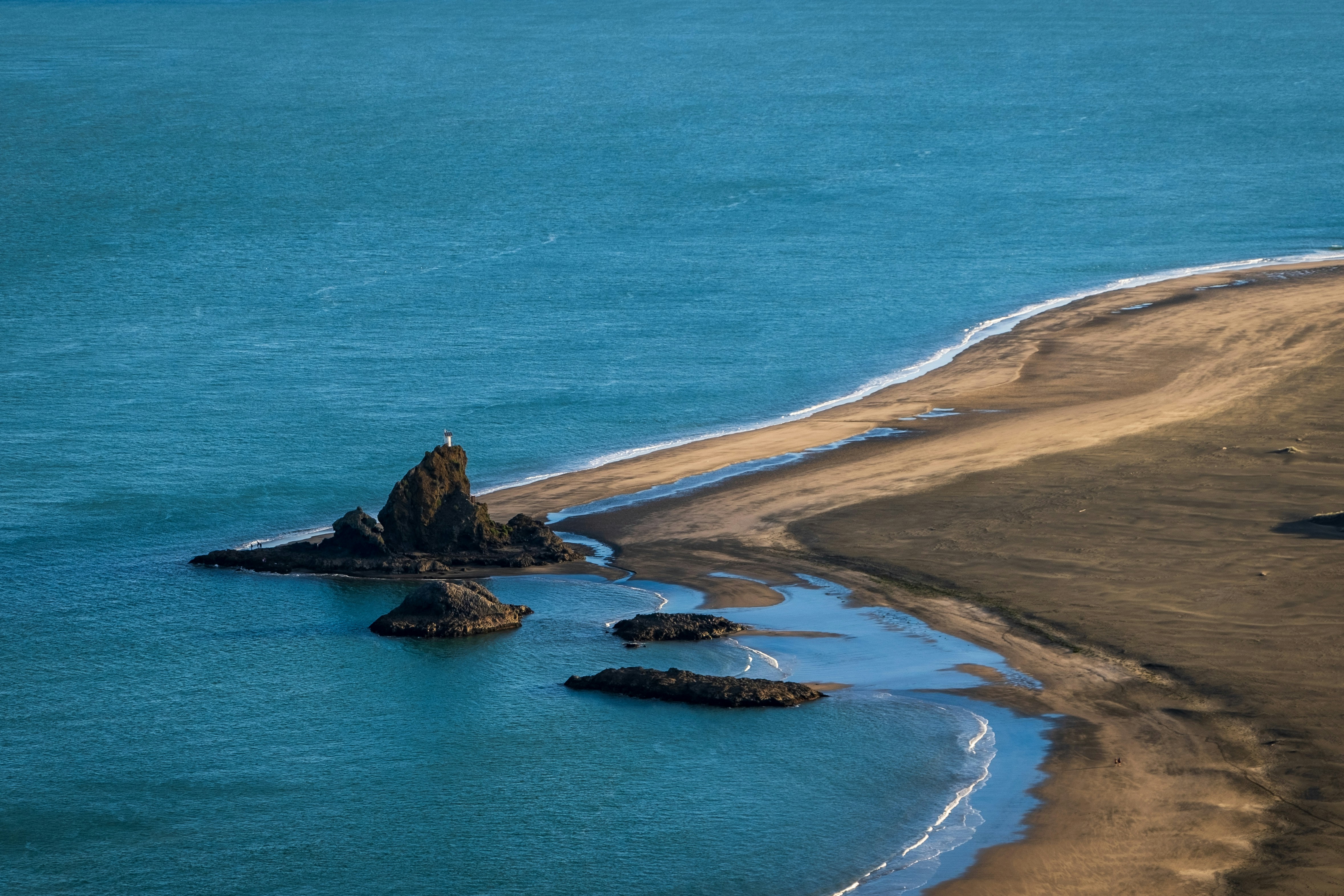 Rock Sentinels Guard a Cerulean Coastal Curve