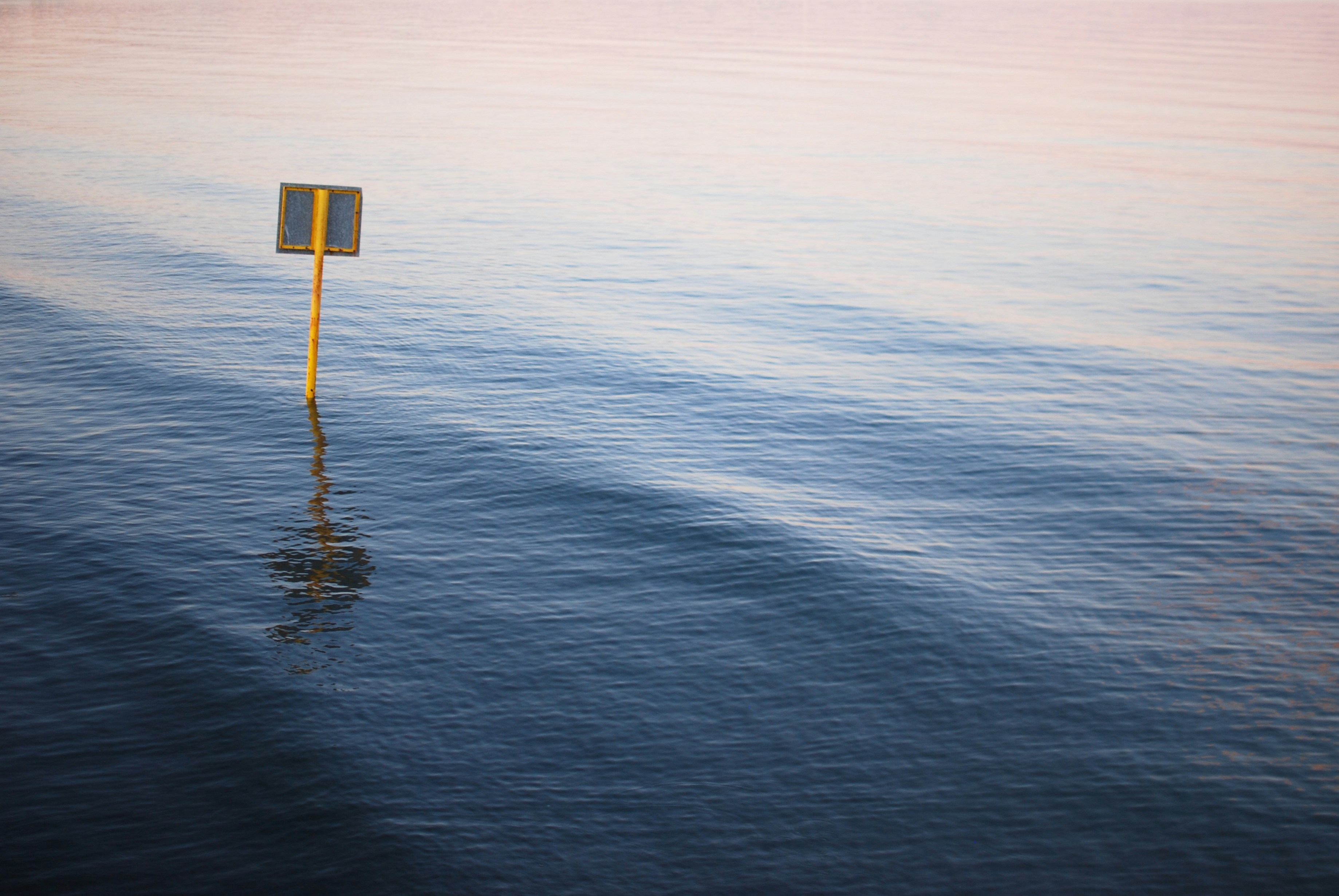 The Yellow Beacon Quietly Standing in a Glassy Sea