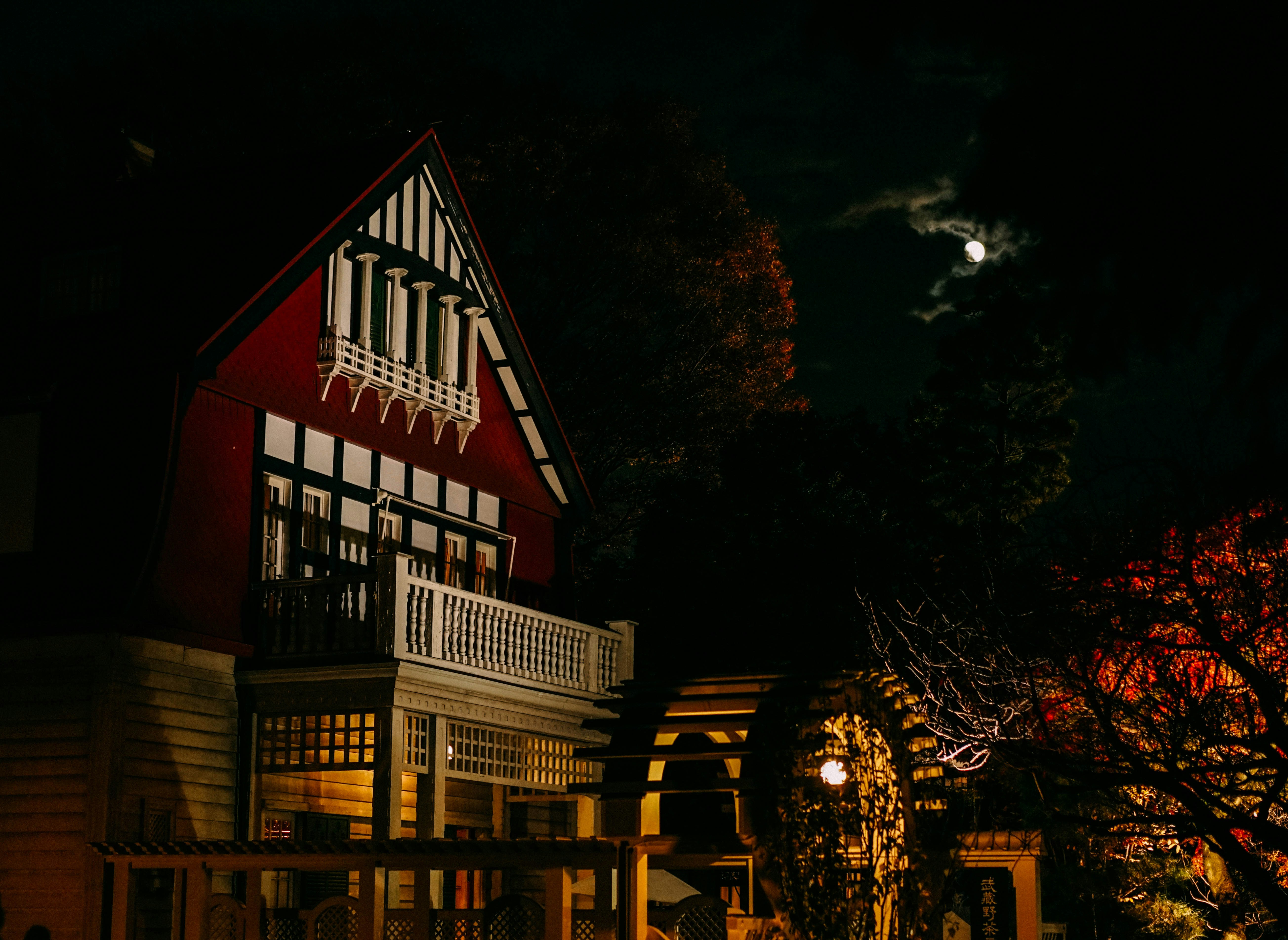 Moonlit Tudor: Warm Lanterns Embrace a Nighttime Facade