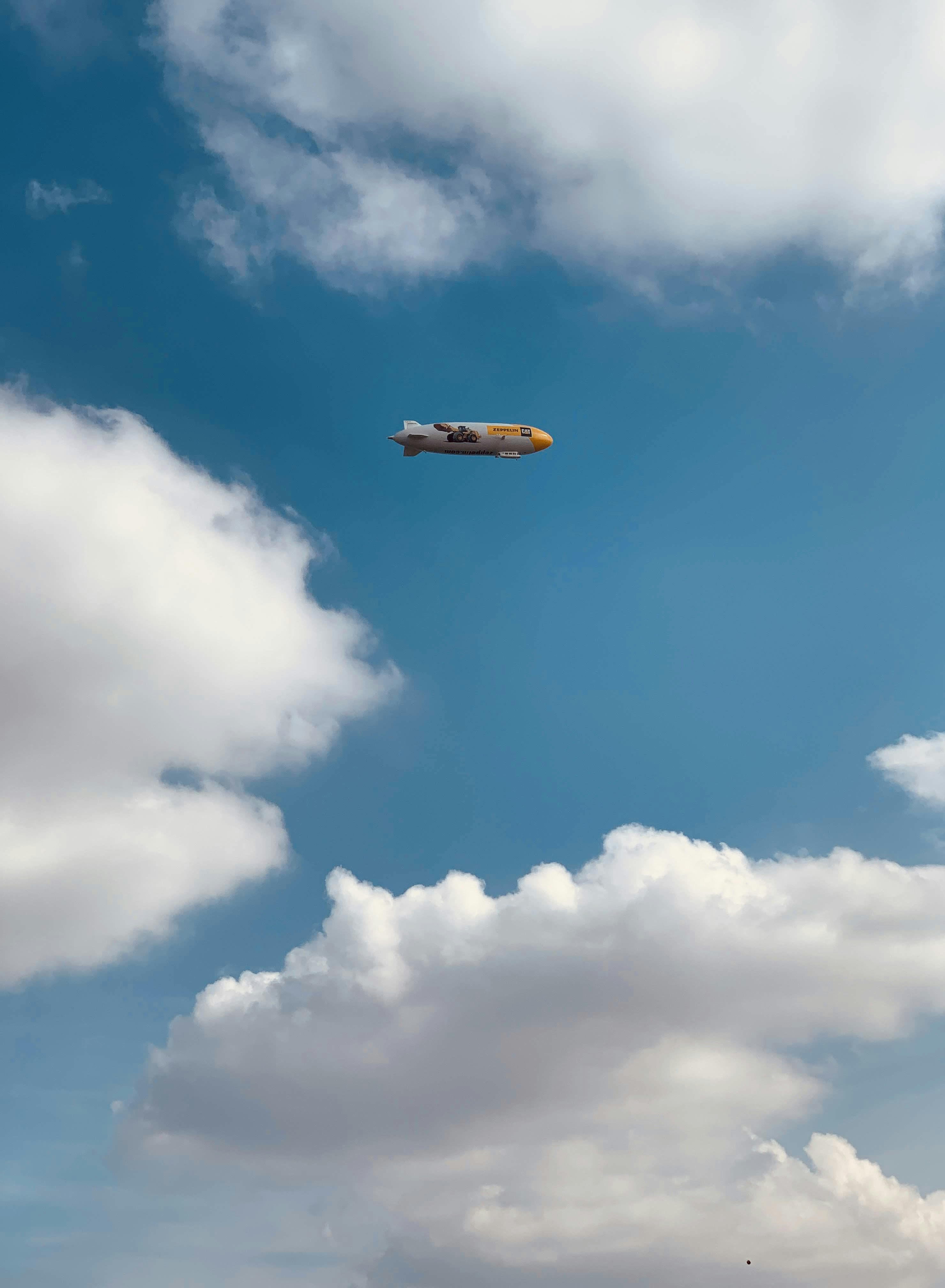 A plane flying in the sky photo – Free Blue Image on Unsplash