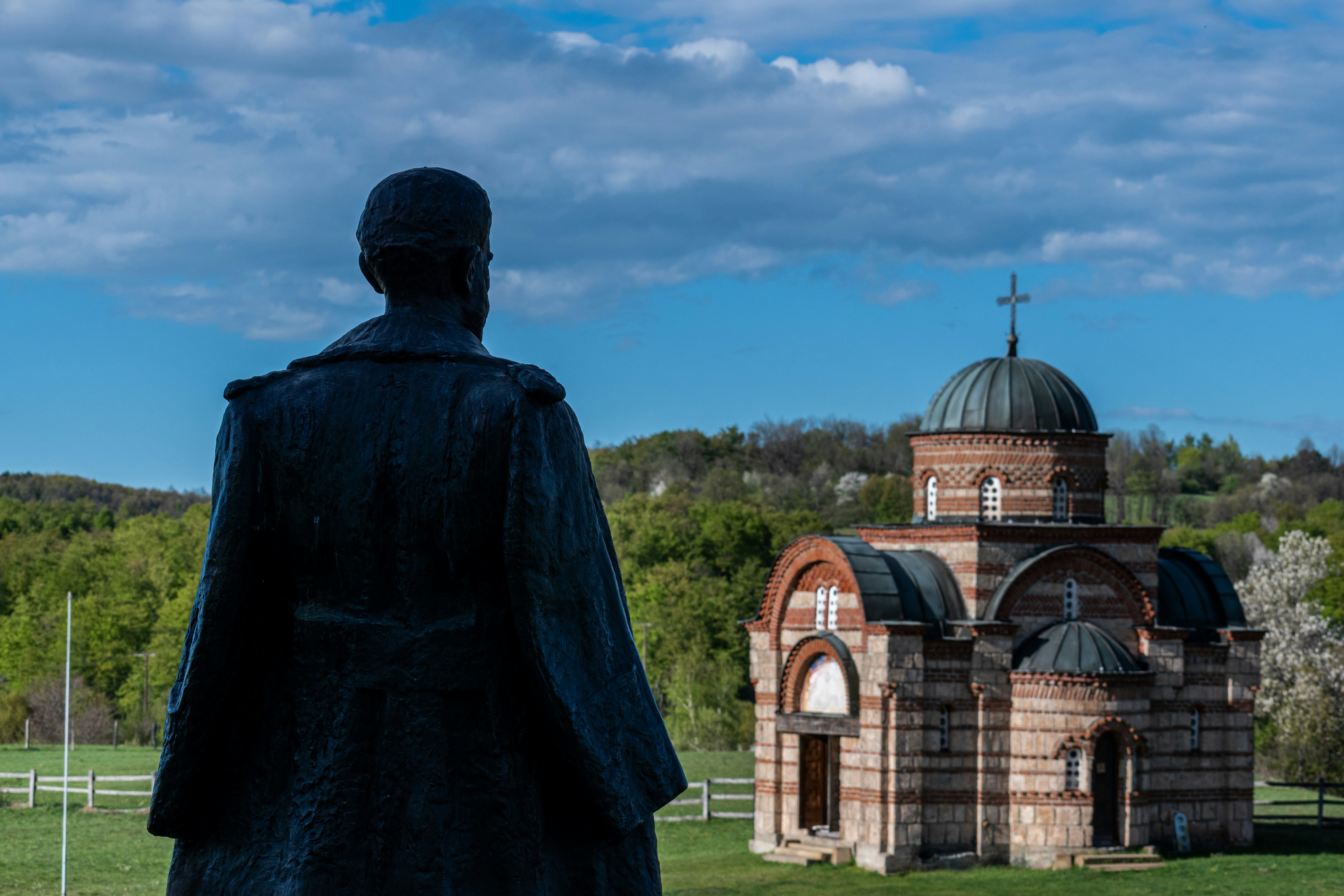 Stone Sentinel Overlooking a Brick-Chapel in a Sunlit Field