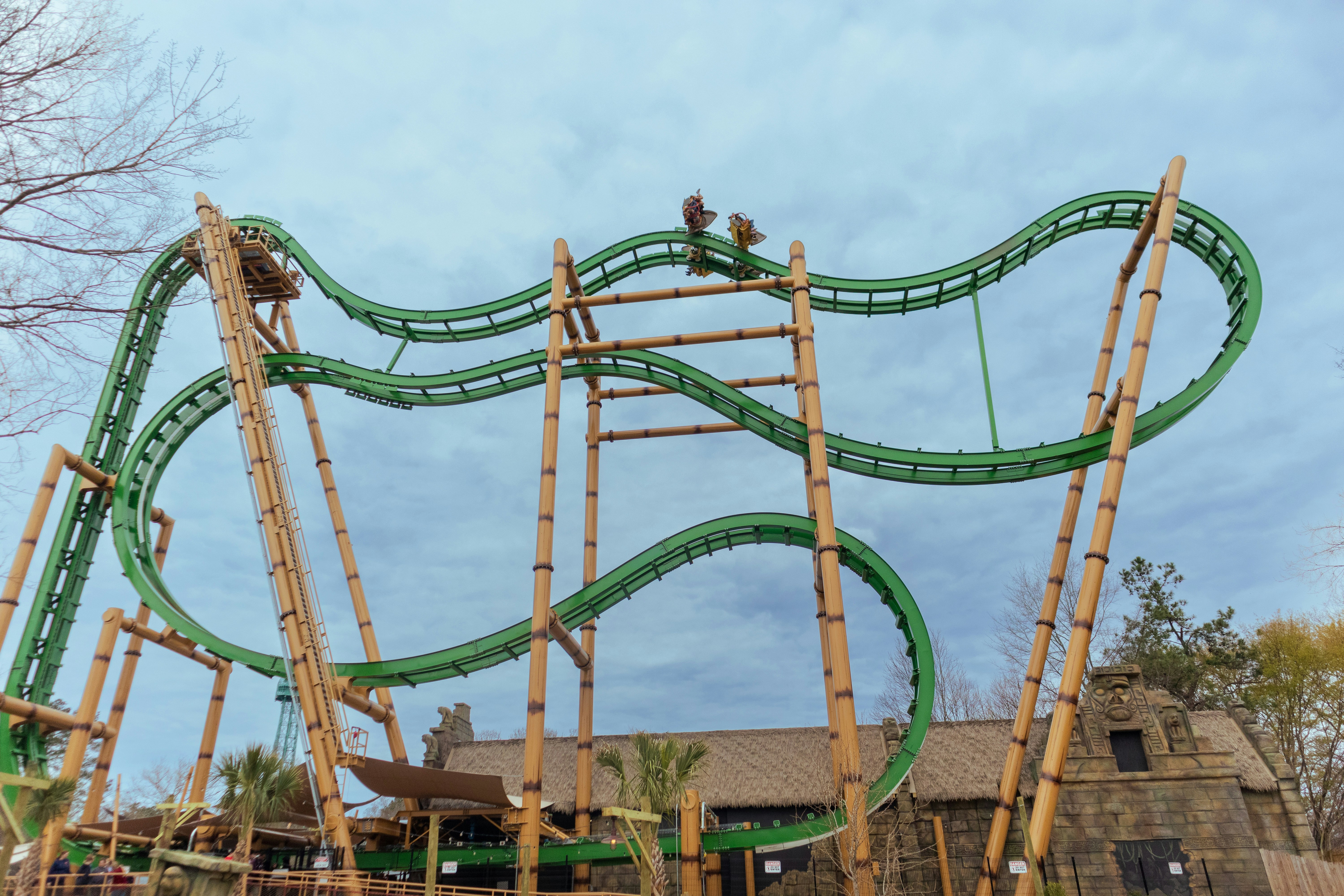 A roller coaster with trees and buildings photo – Free Theme park way ...