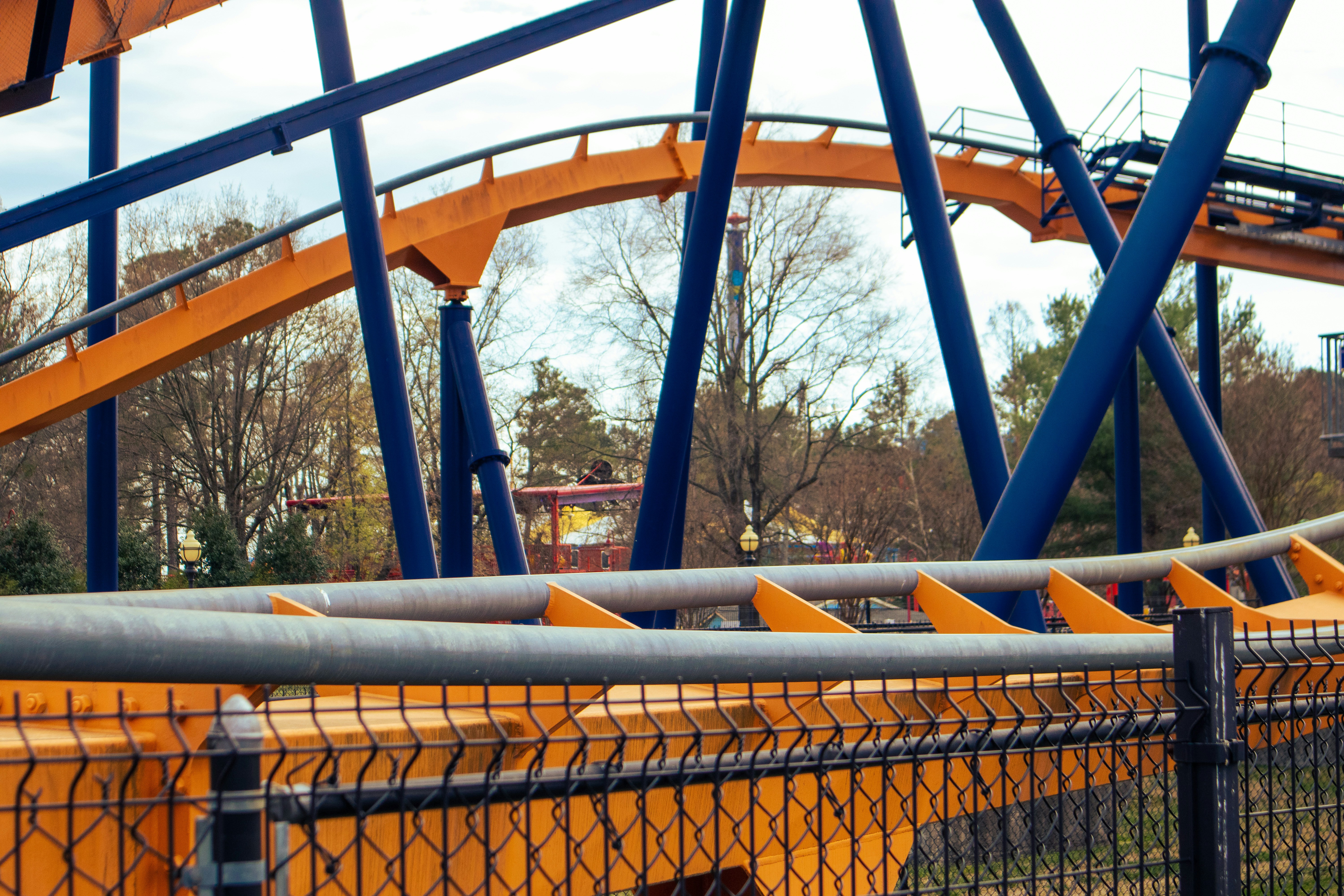 A roller coaster with a fence around it photo – Free Kings dominion ...