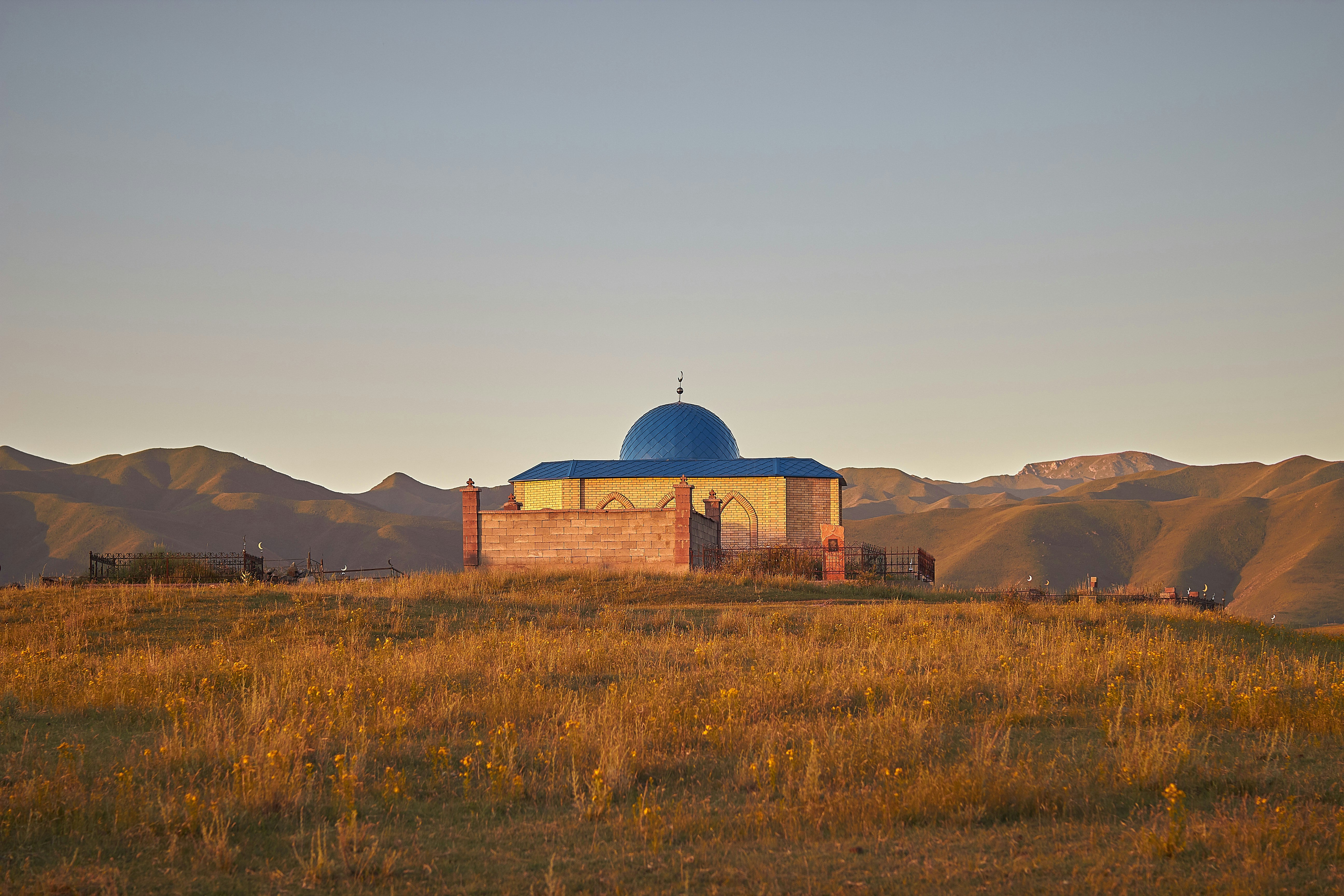 Blue-Domed Chapel on a Golden Crest at Dusk