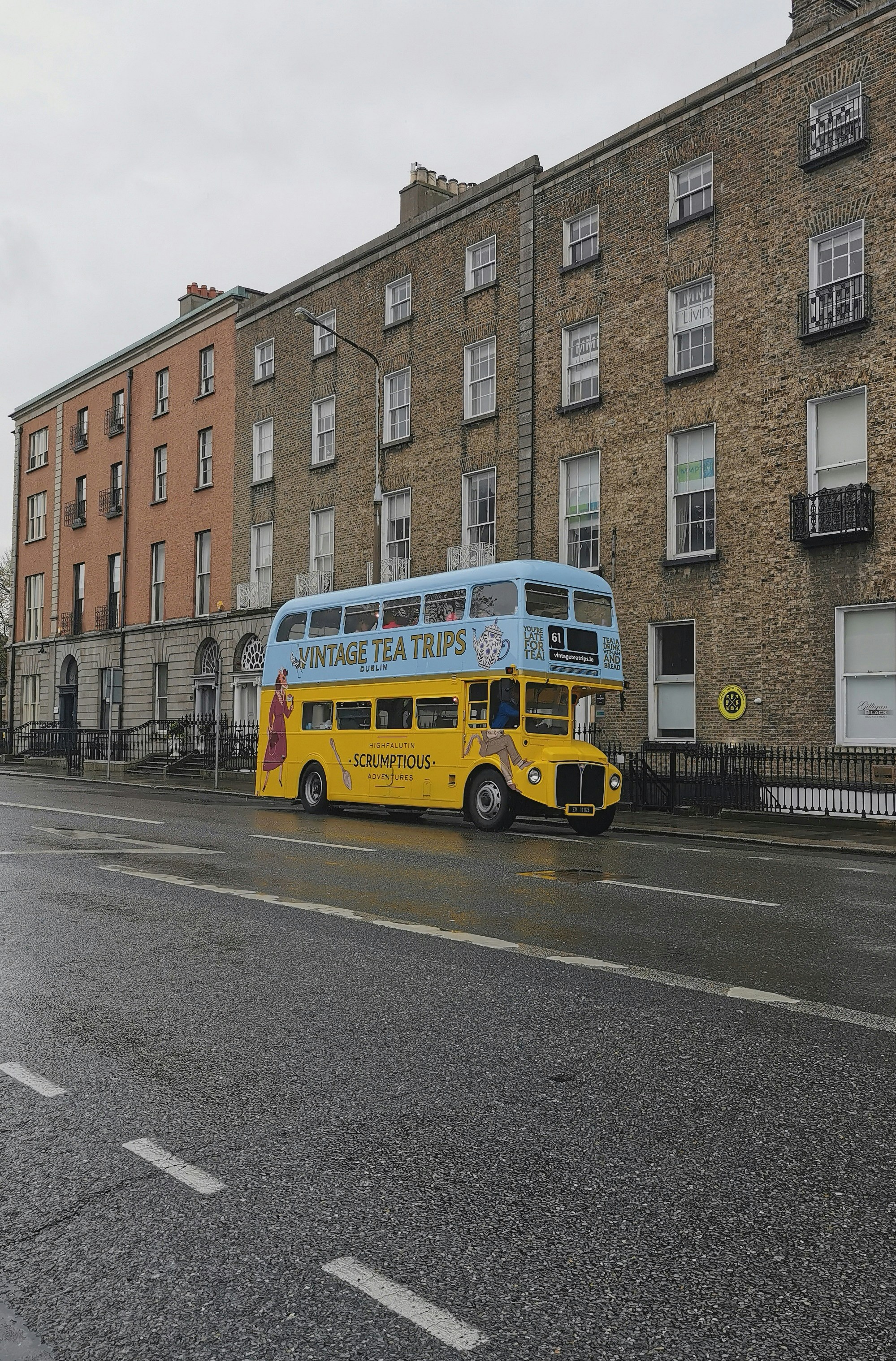 Blue-Top Double-Decker Bus on a Rain-Soaked City Street