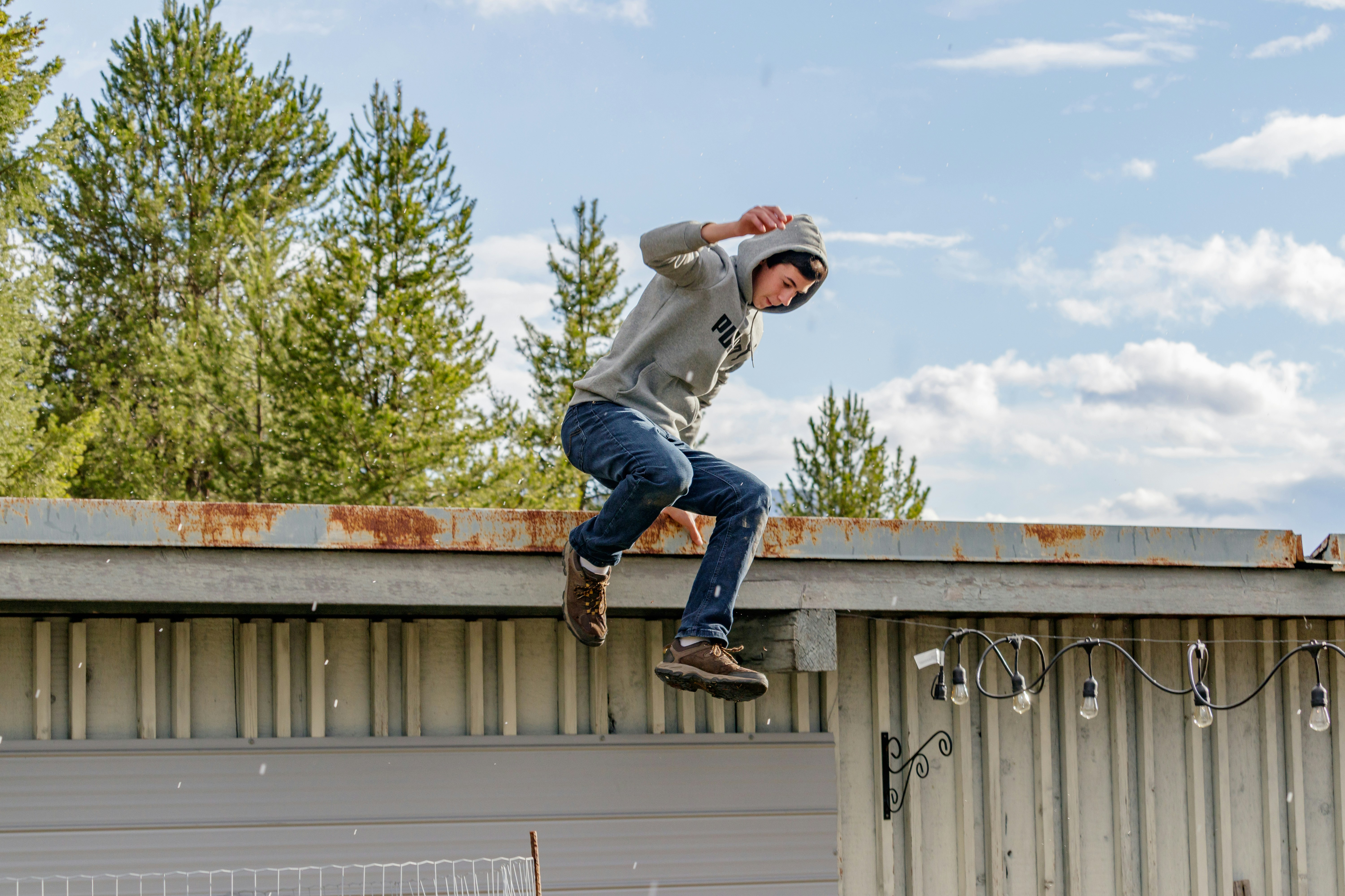 A man jumping on a roof photo – Free Leaping Image on Unsplash