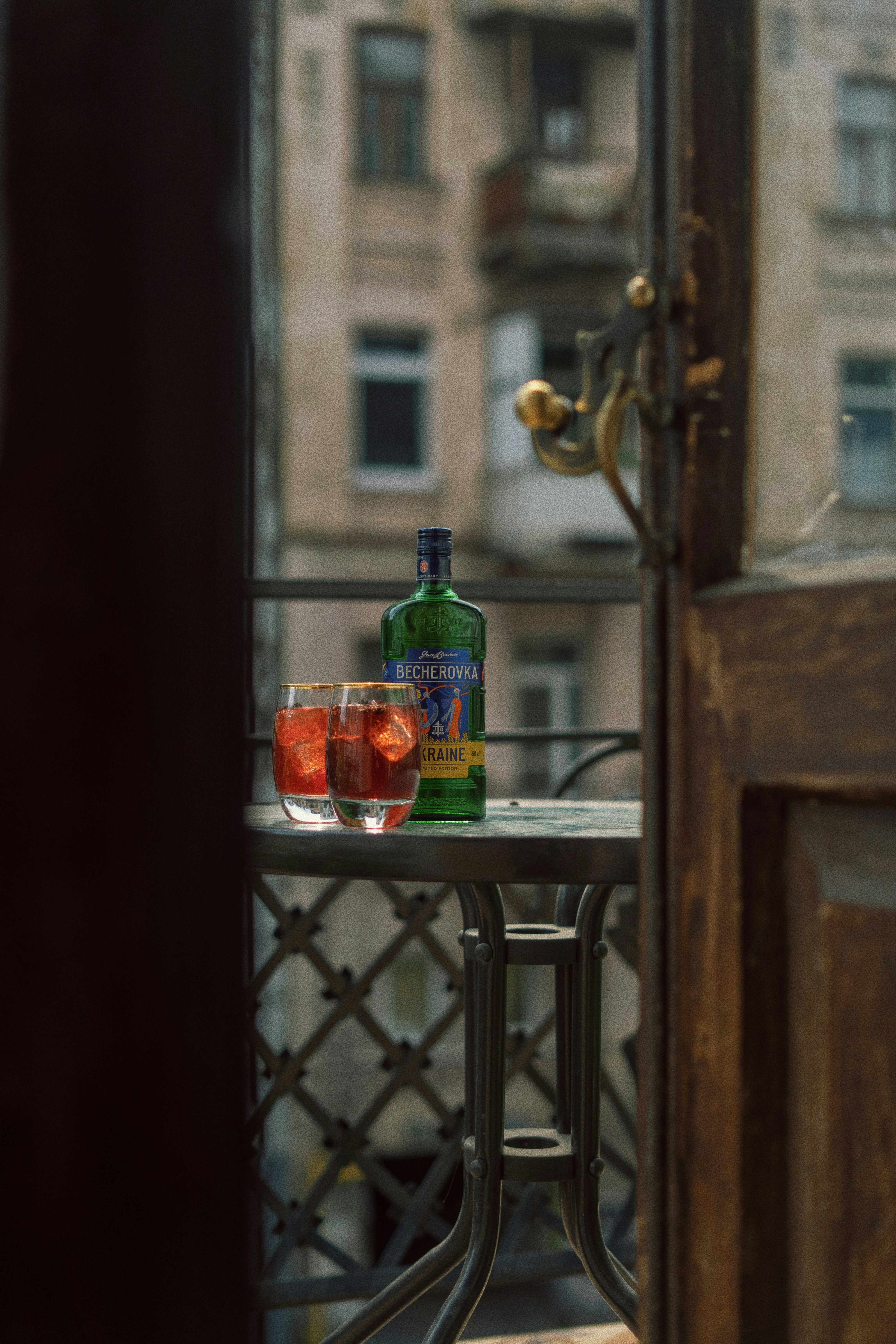 a bottle of soda and a glass of beer on a table
