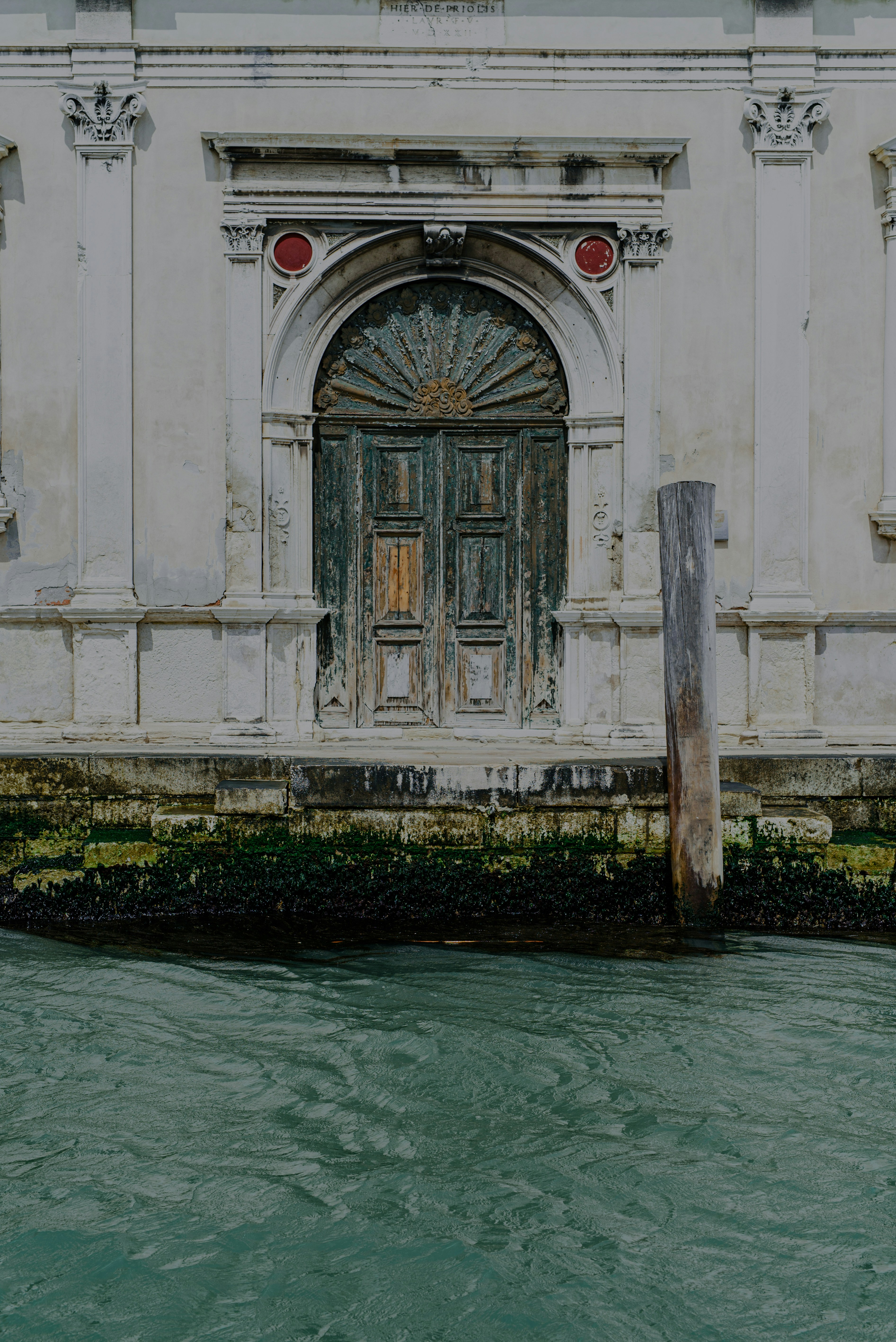 Sunburst Arch Over a Weathered Canal Door
