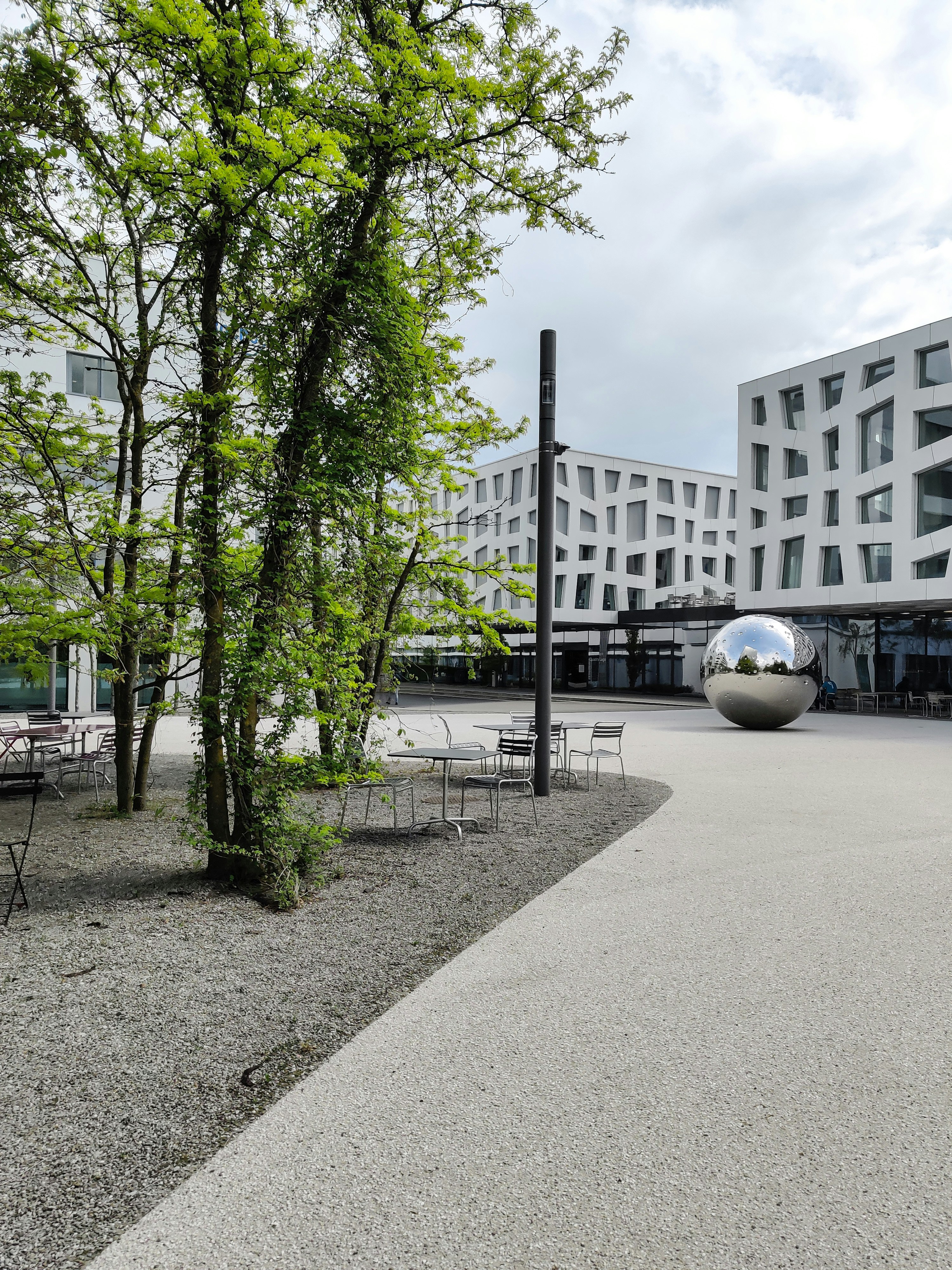 Chrome Sphere Anchors a Minimalist Campus Plaza