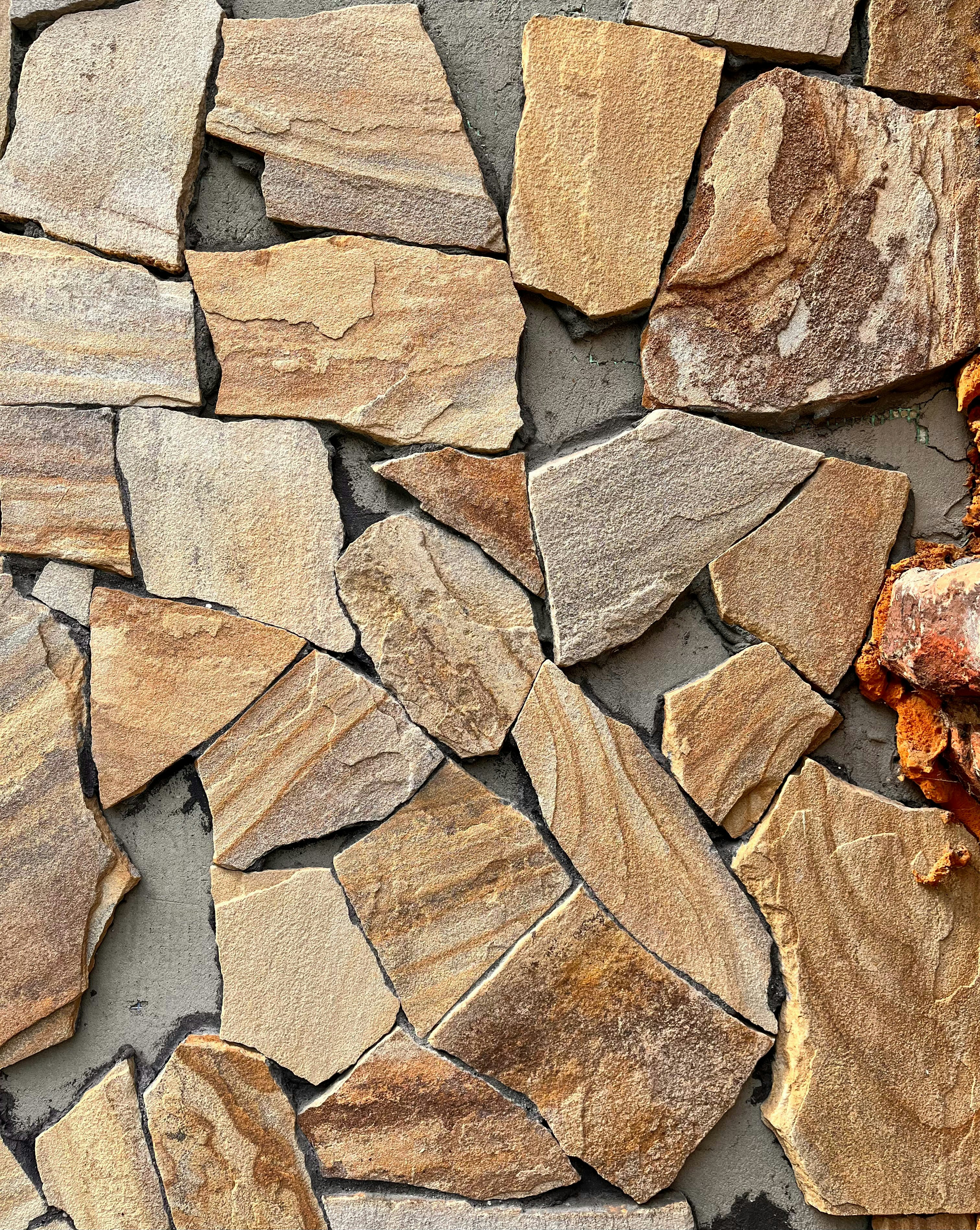 Earth-Toned Cobble Mosaic: Close-Up of an Irregular Stone Wall