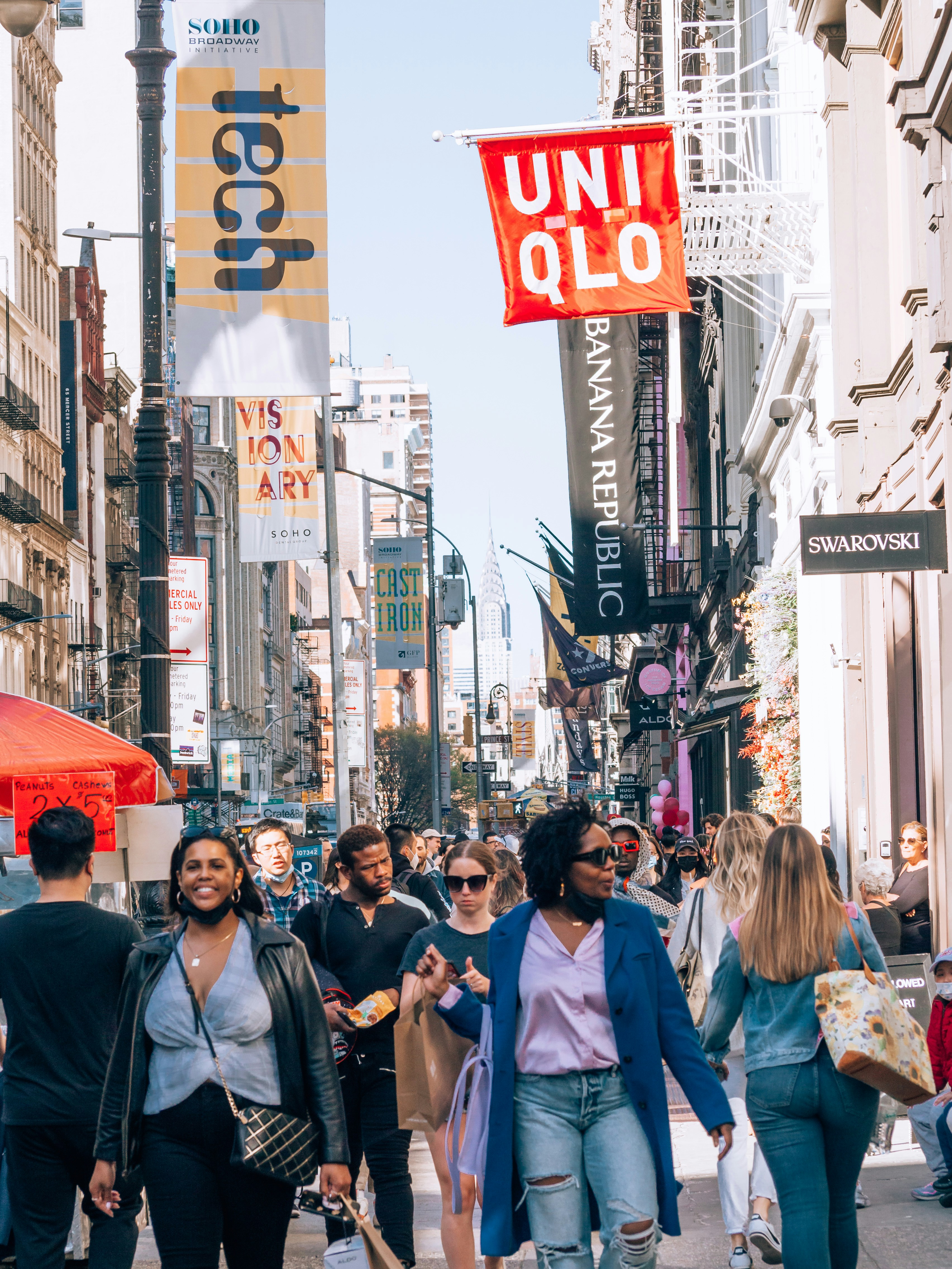 A group of people walking down a busy street photo – Free Soho Image on ...