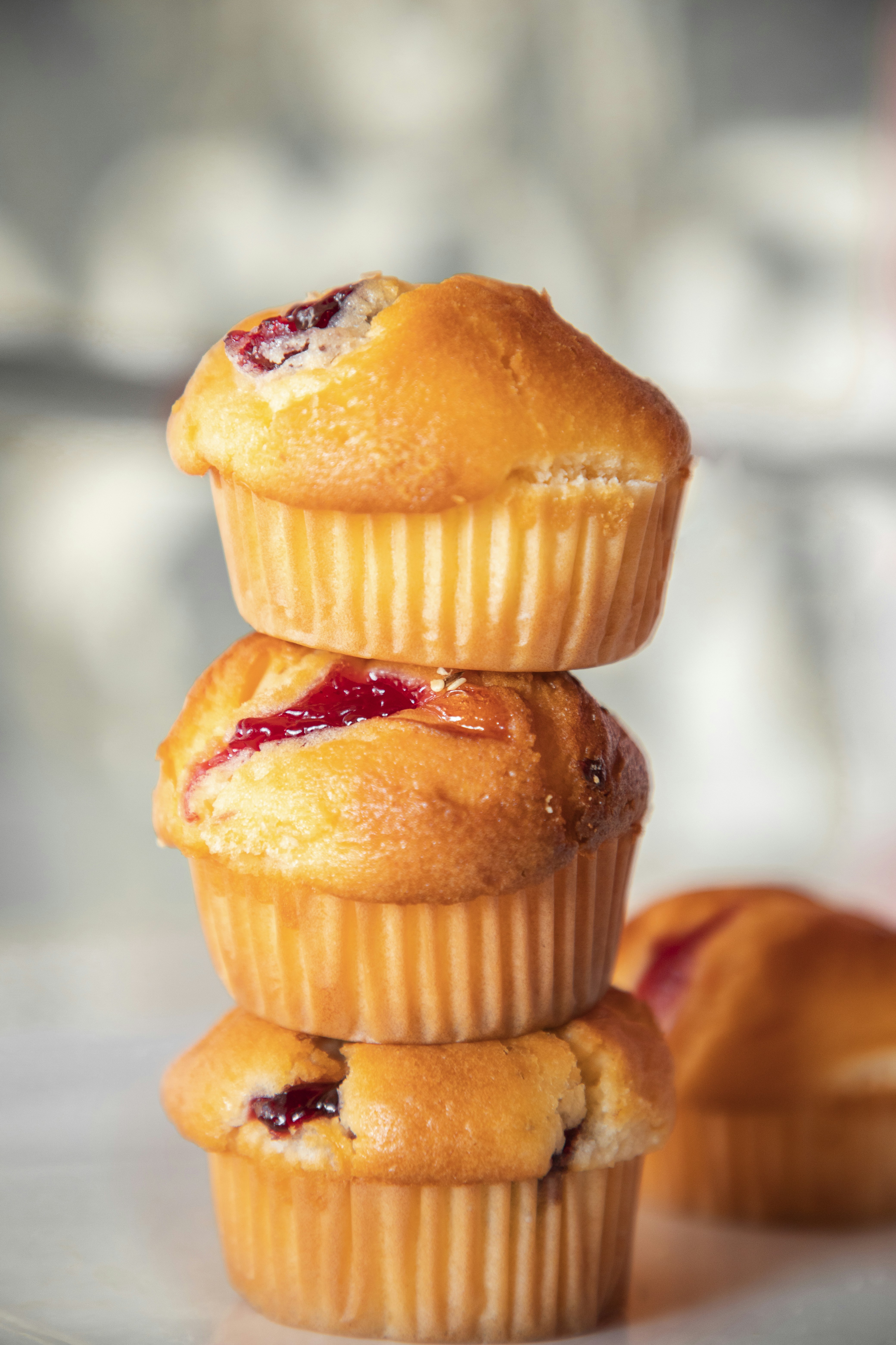 Three-Tiered Vanilla Bliss: A Stack of Raspberry-Studded Muffins