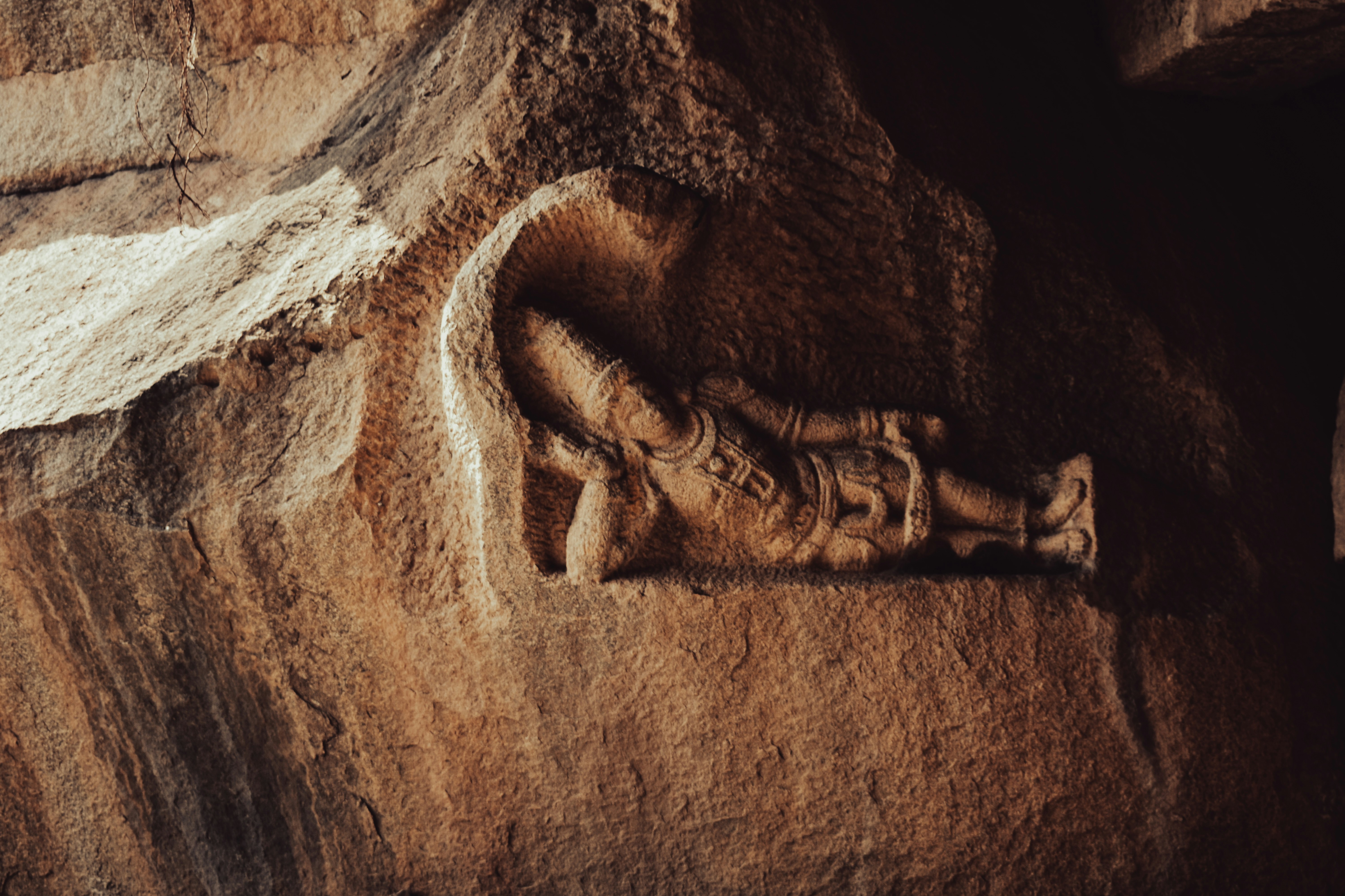 Slumbering guardian: a weathered statue carved into stone