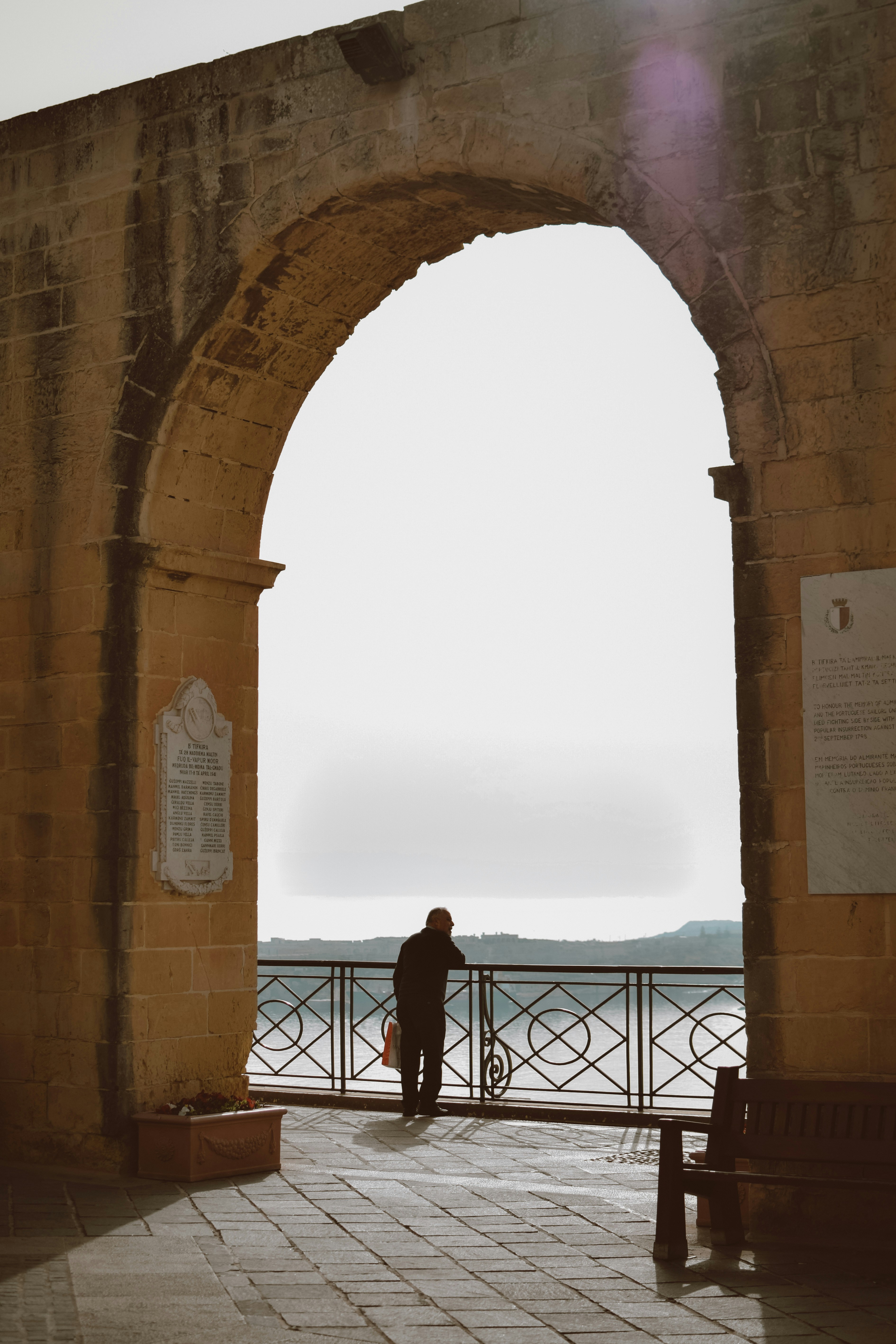 Archway of Quiet Moments: A Lone Figure Overlooking the Sea