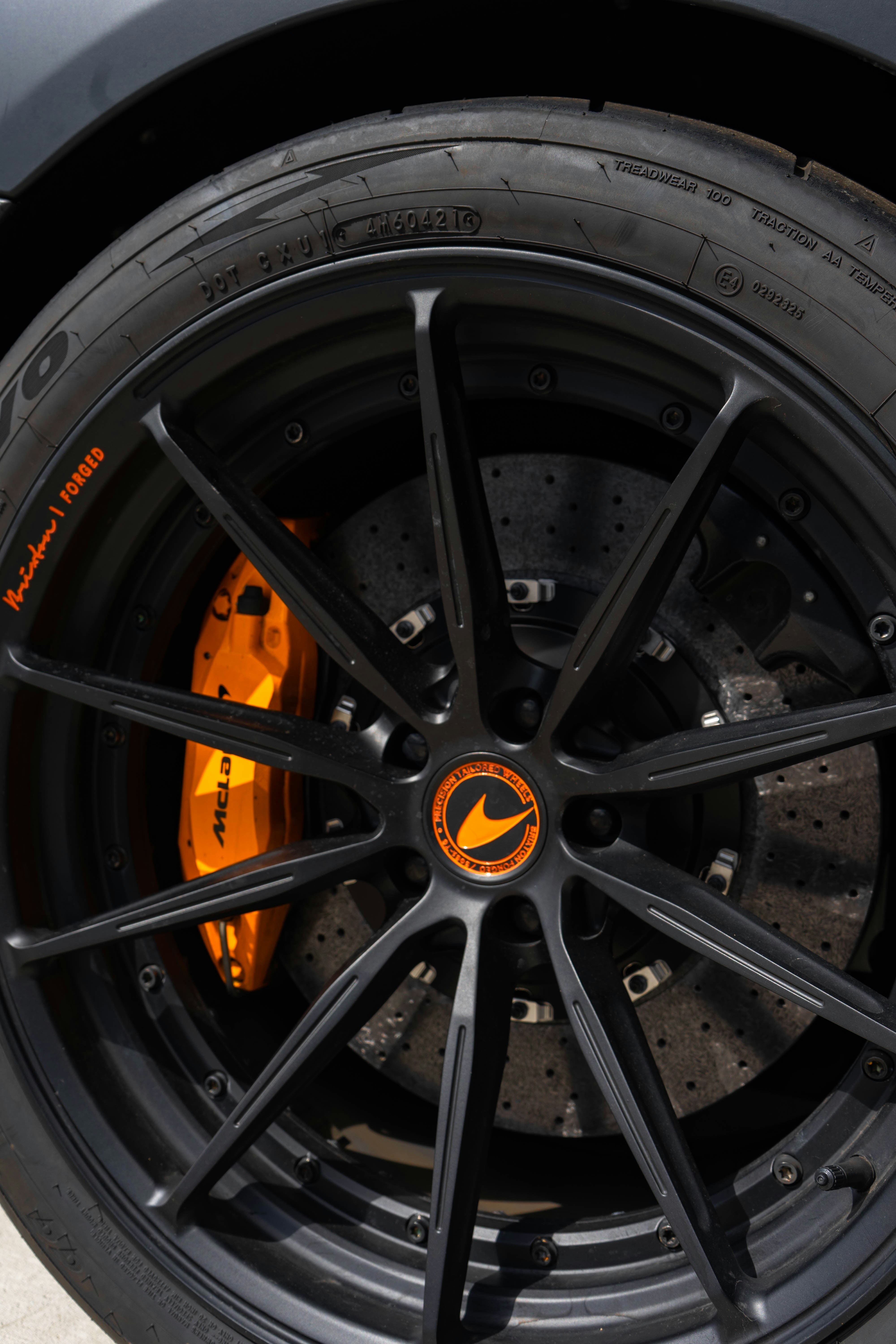 Orange Bolt: Close-Up of a High-Performance Wheel and Brake Assembly