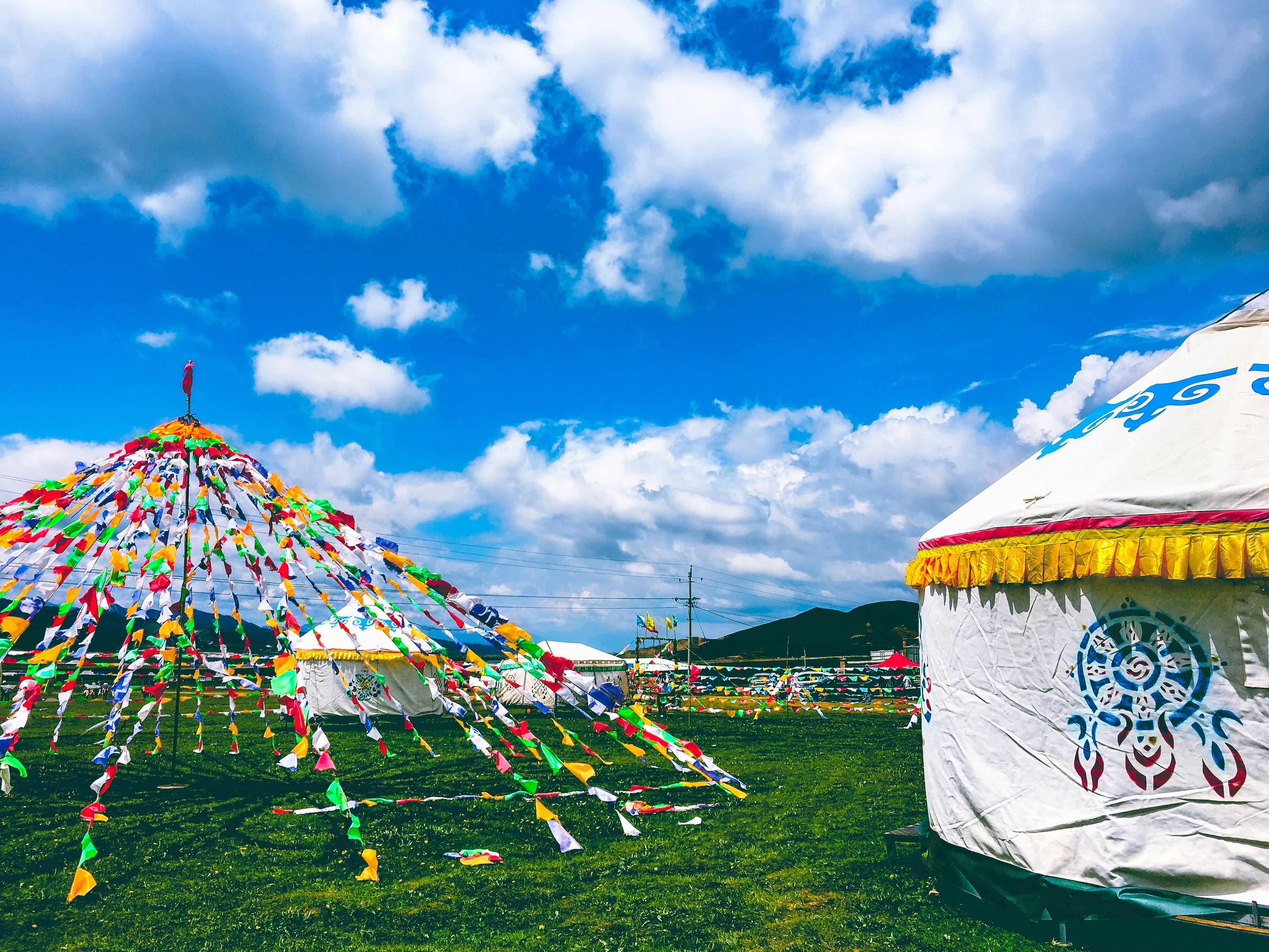 a group of tents with flags