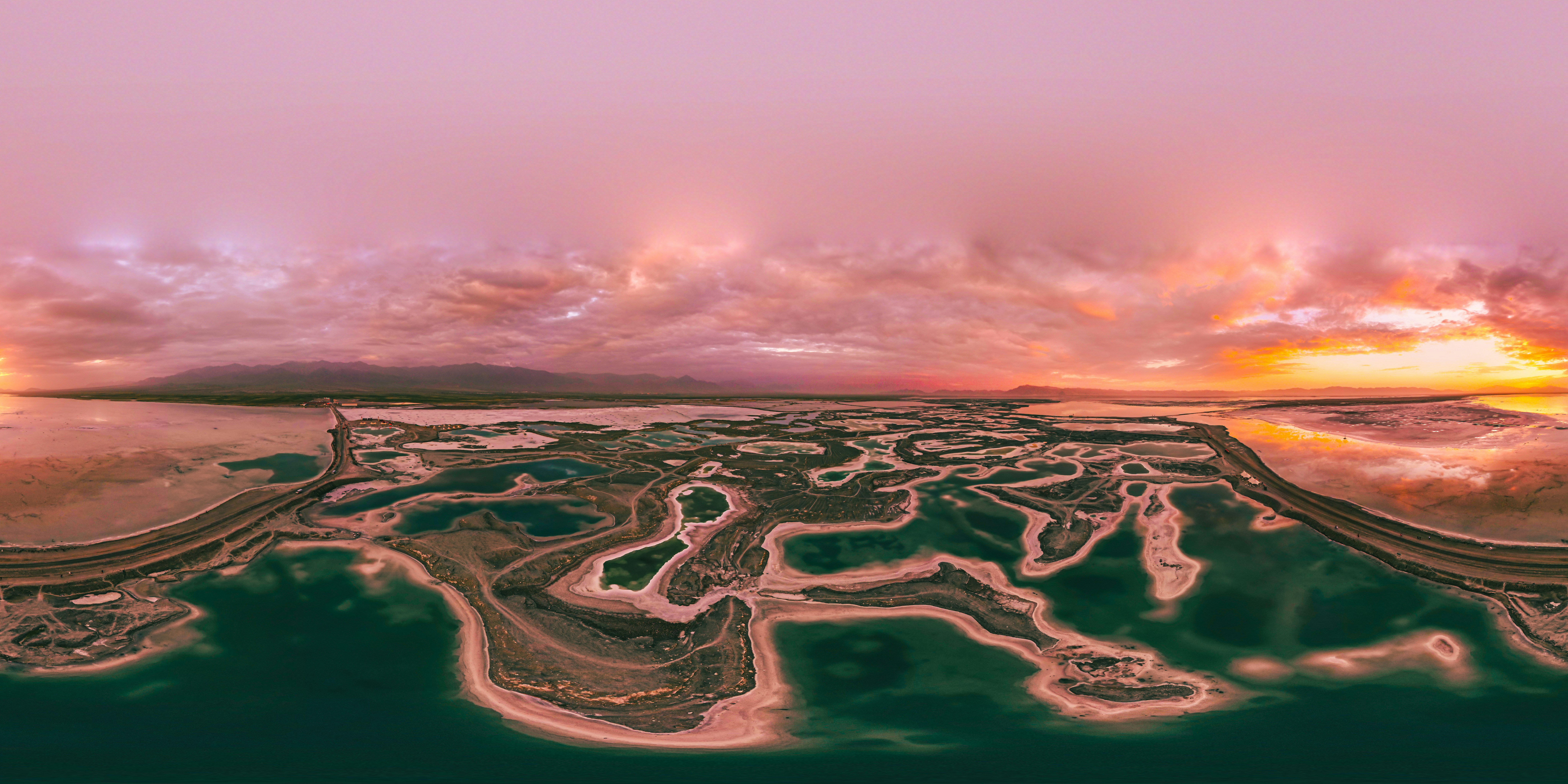 a large flat area with a body of water in the distance