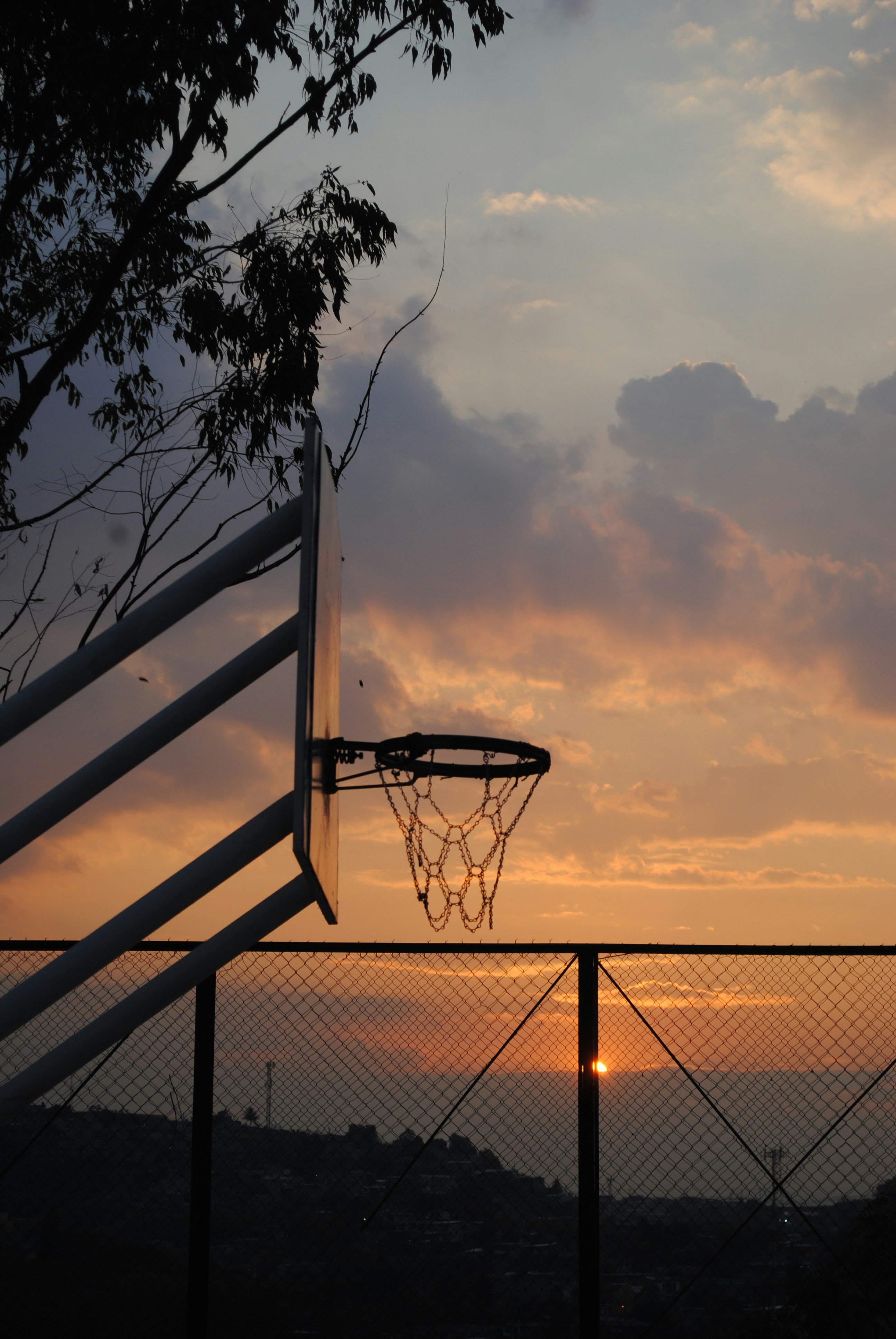 A basketball hoop with a sunset in the background photo – Free Sunset ...
