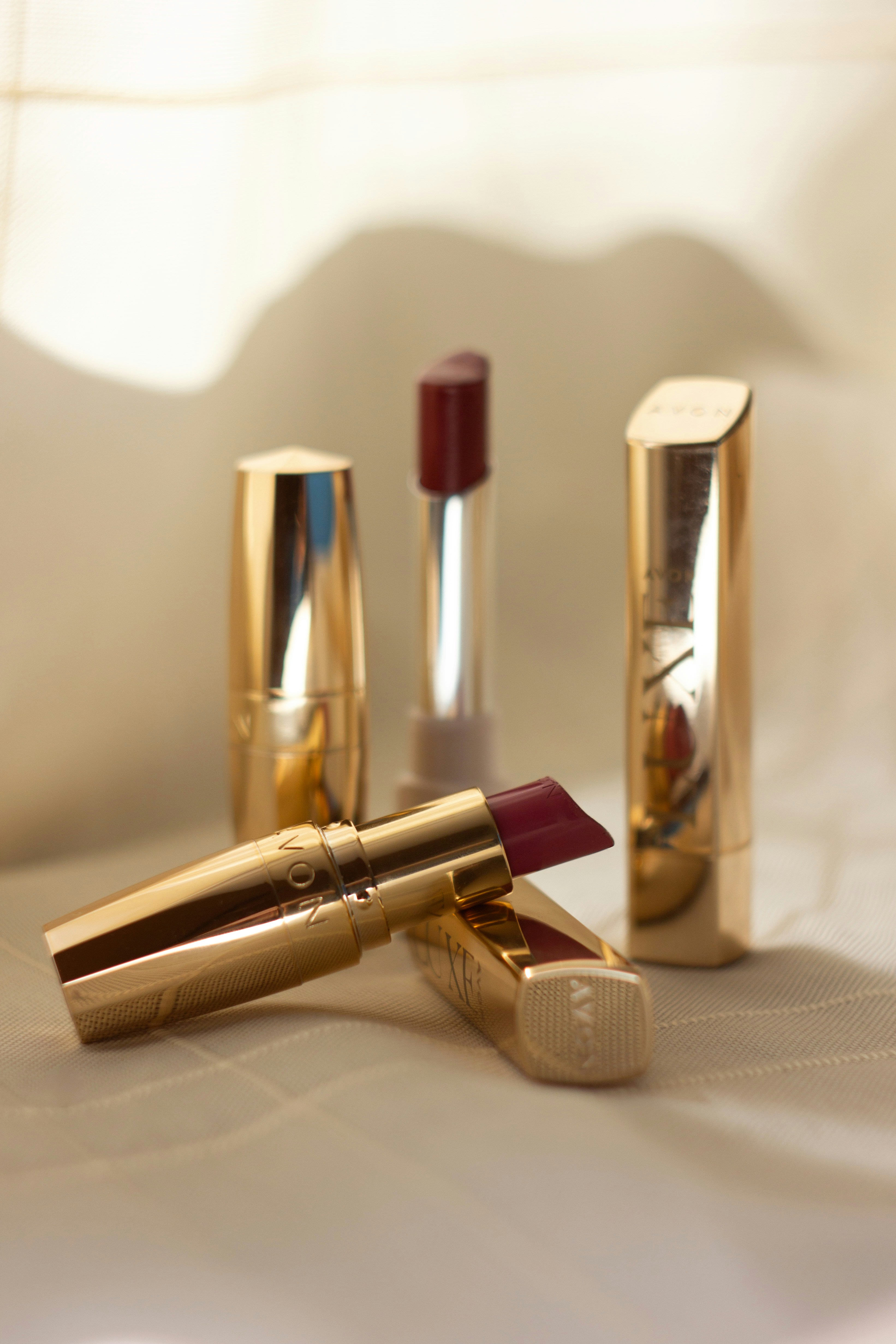 A set of gold and red bullets photo – Free Cosmetics Image on Unsplash