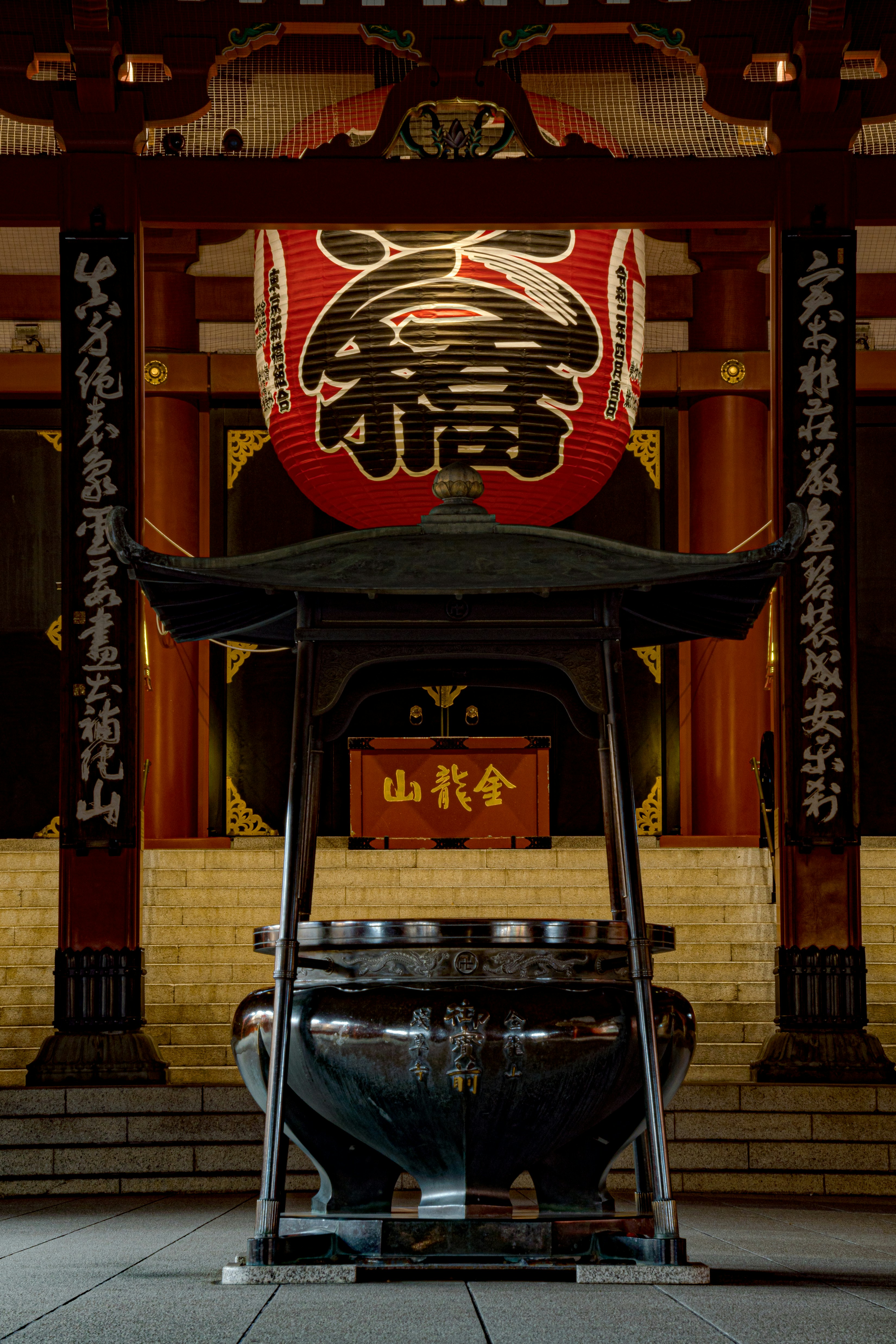 Lantern Over Shrine: A Sacred Moment Framed by an Iron Vessel