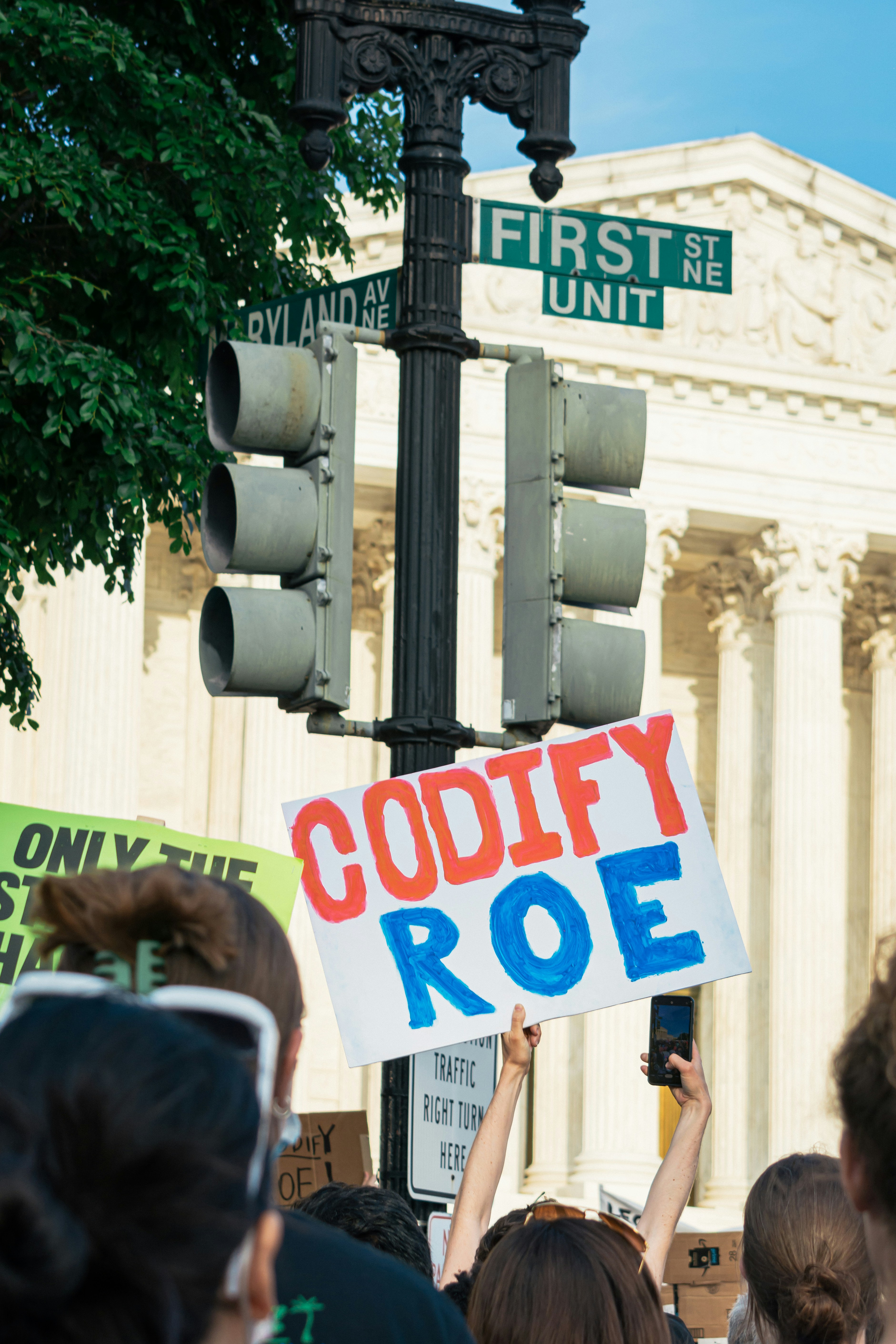 A group of people stand near a traffic light photo – Free Dc Image on ...