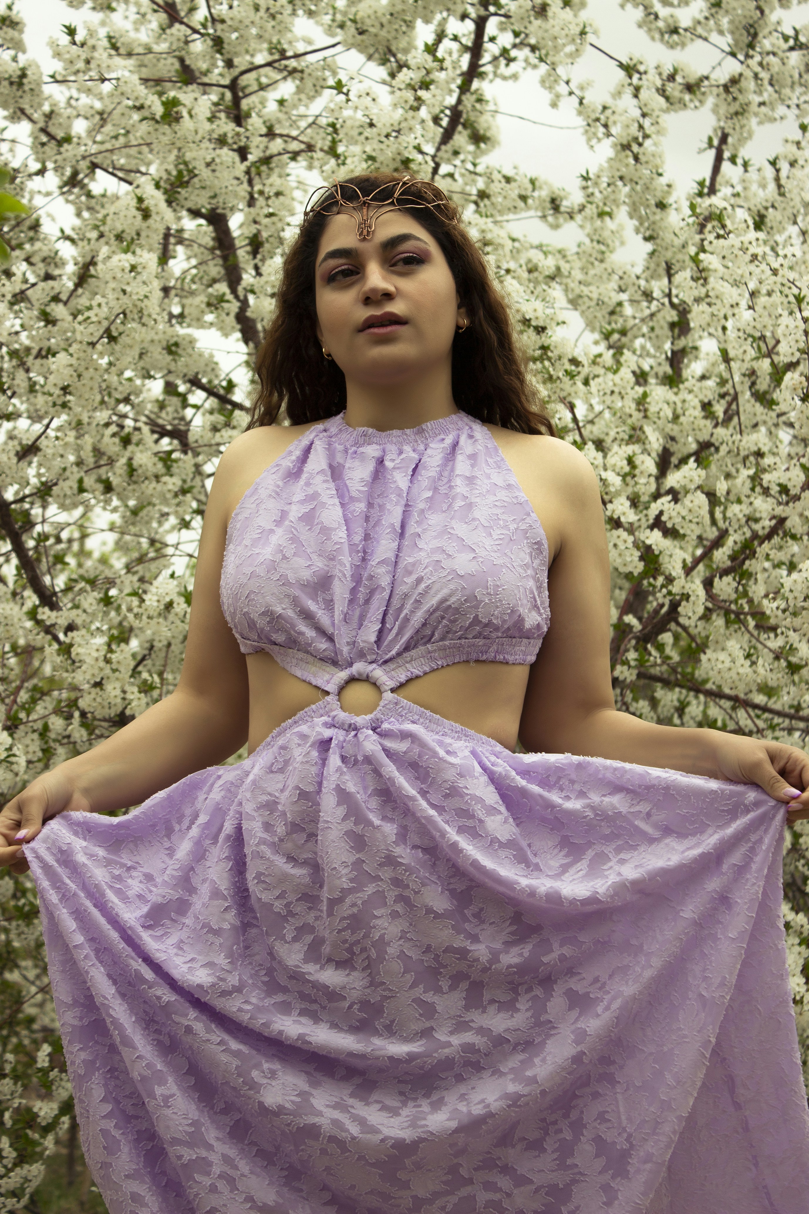 Lilac Garb Under a White Blossom Canopy: Portrait in Spring Orchard