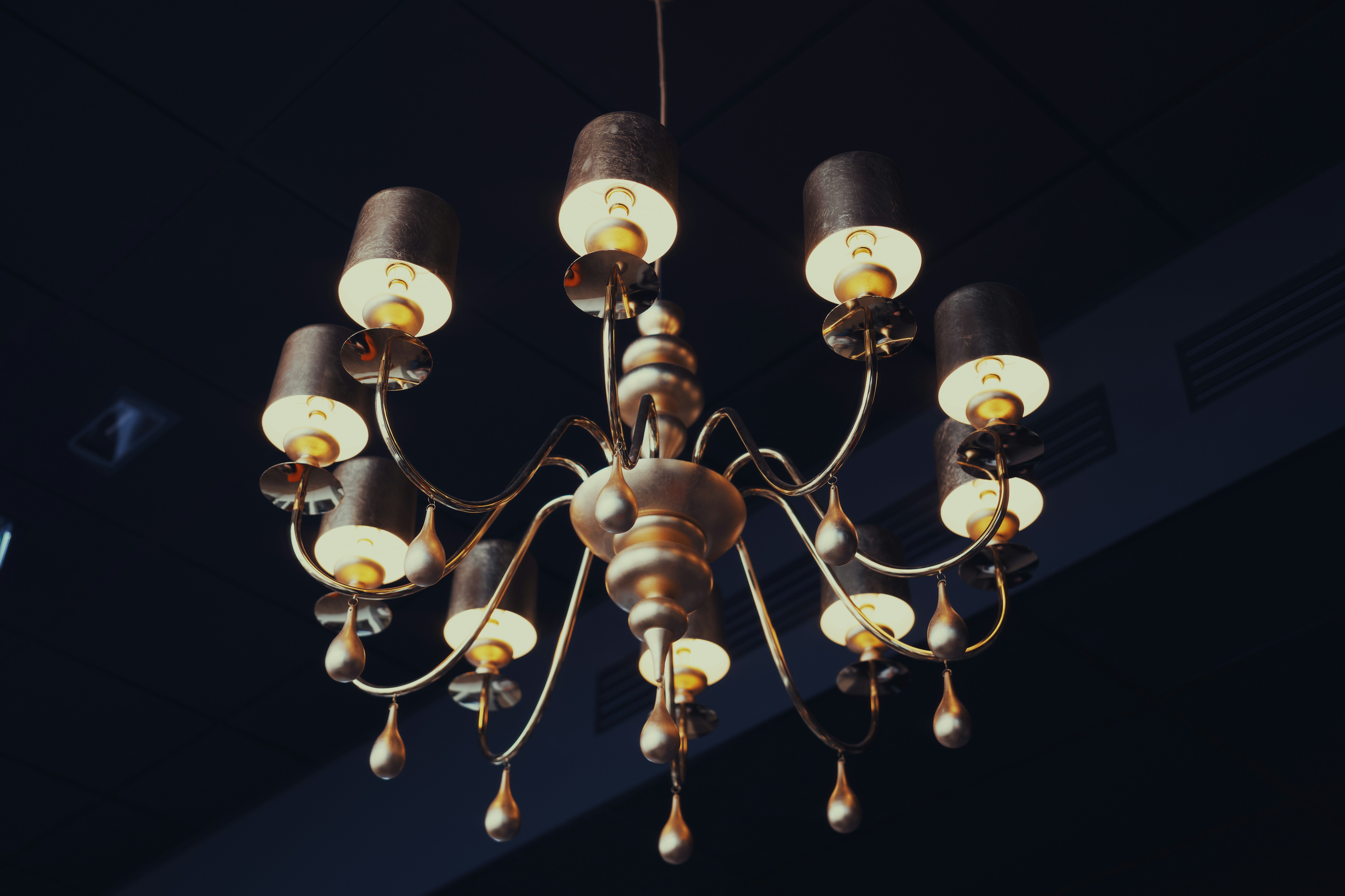 Brass Halo in Velvet Night: An Amber-Chandelier Casts Quiet Light