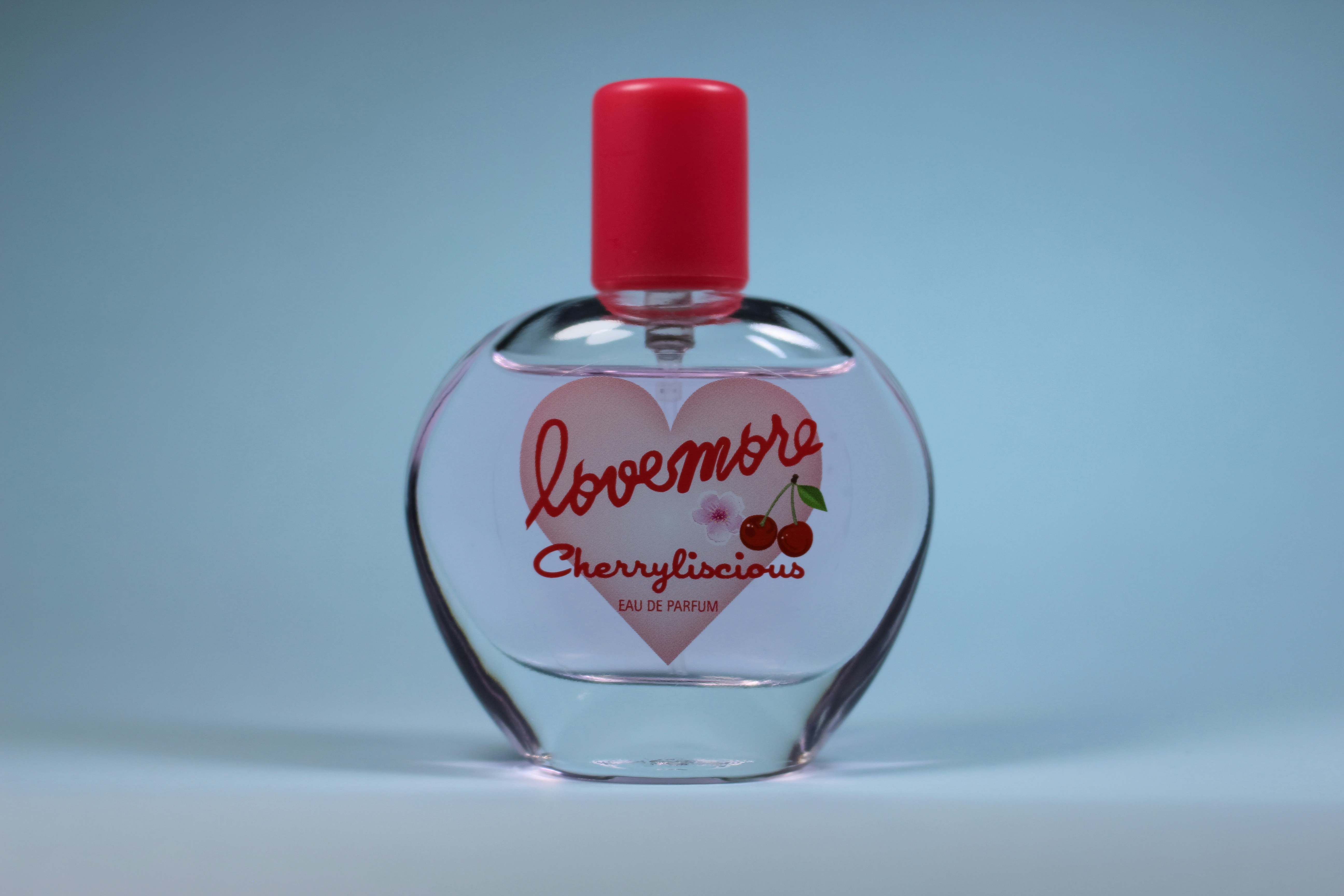 a small bottle of perfume on a plain studio background