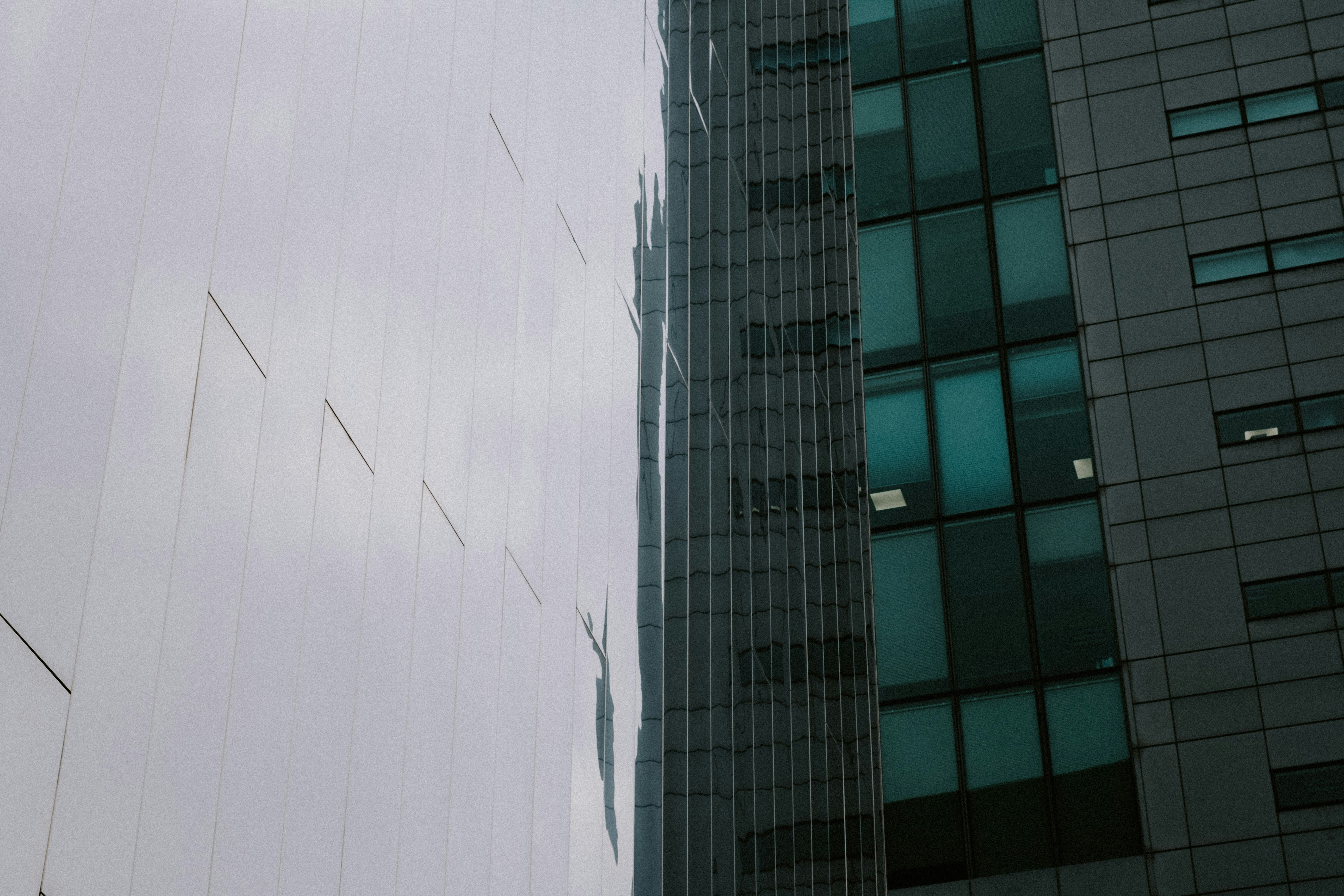 A modern cityscape showcasing the interplay of reflective surfaces and architectural lines, highlighting the sleek design of contemporary buildings.