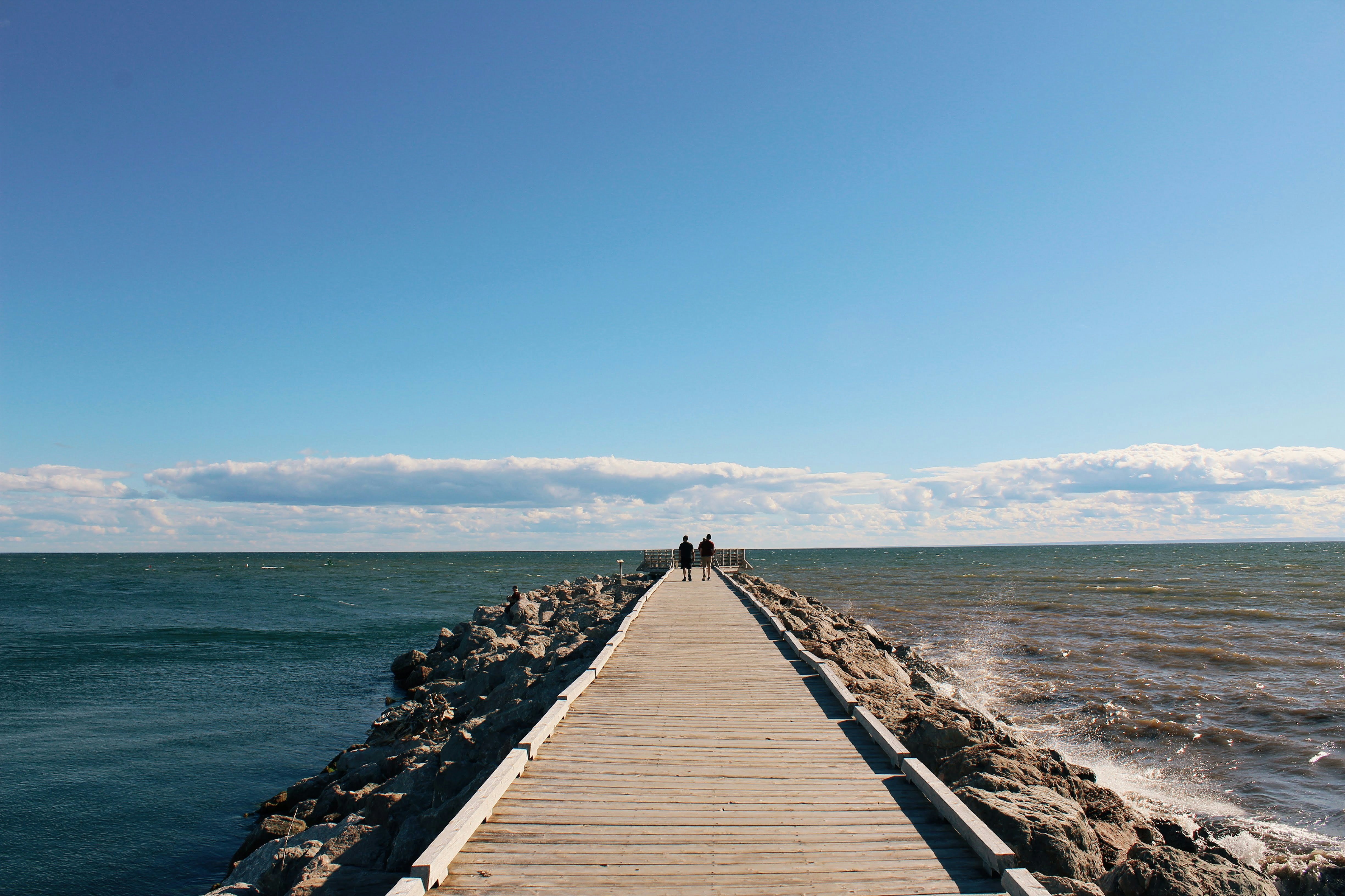 A wooden walkway over water photo – Free Blue Image on Unsplash