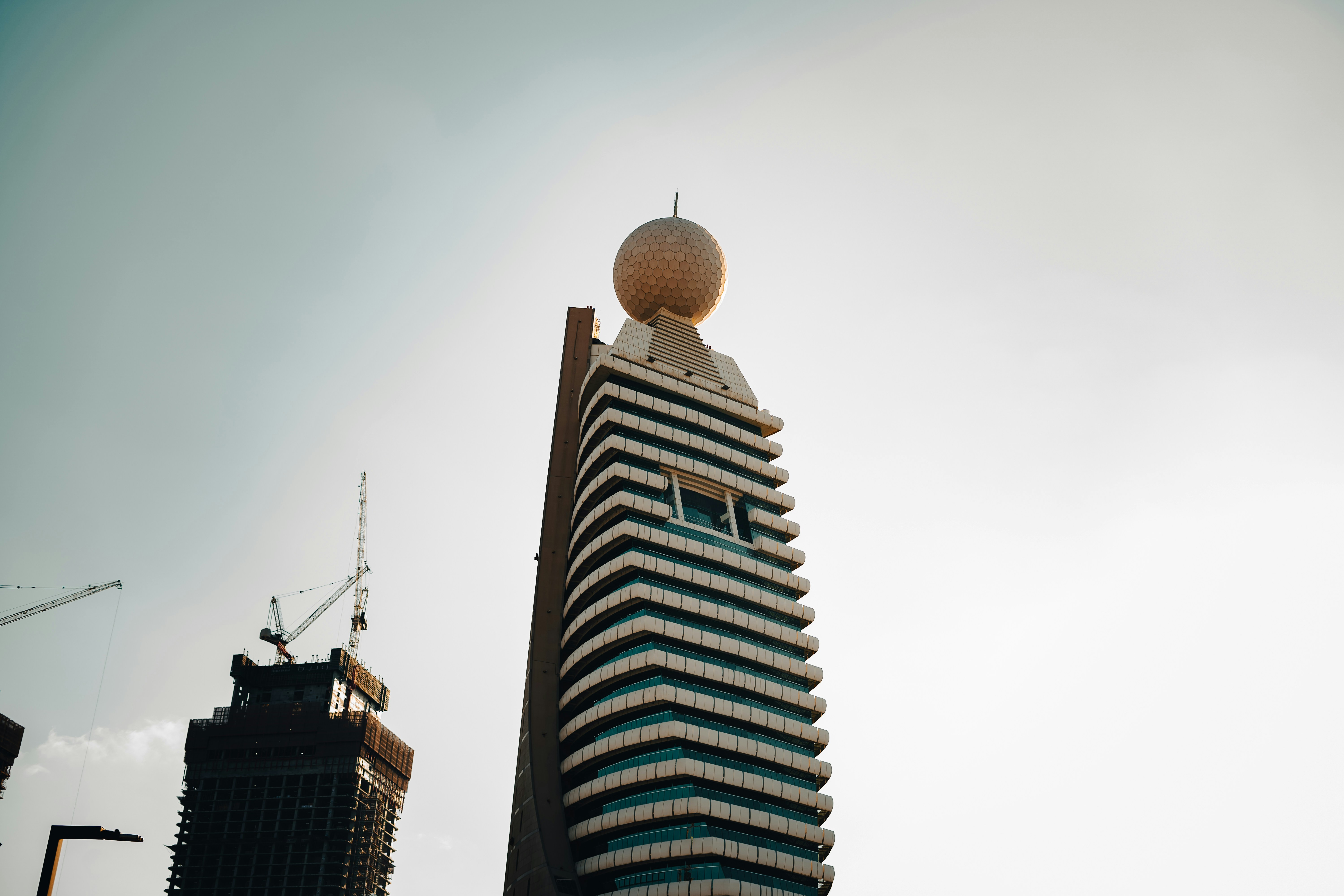 A couple of skyscrapers with a ball on top photo – Free Building Image ...