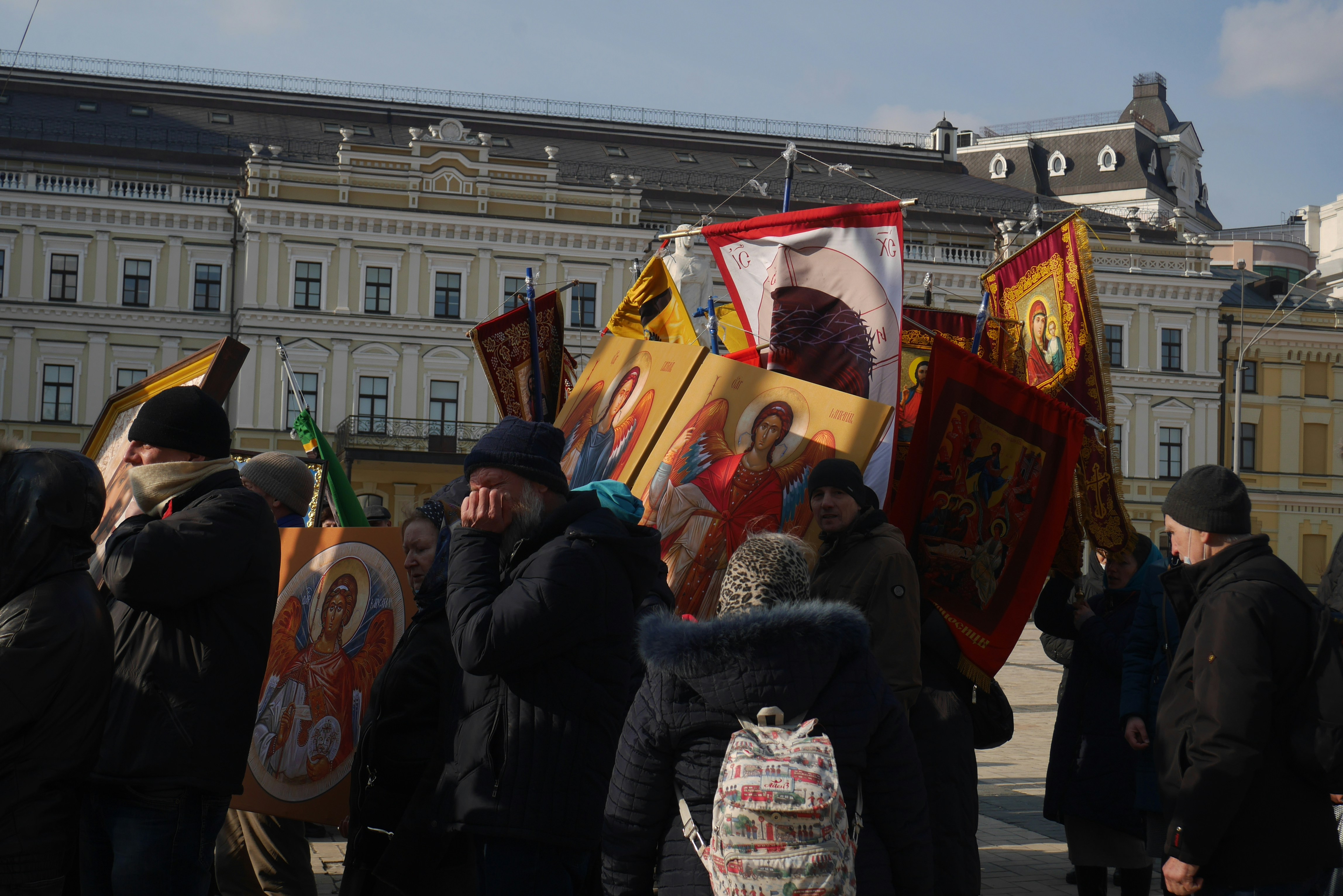 Pilgrims with Icon Parasol Props in a Historic Square