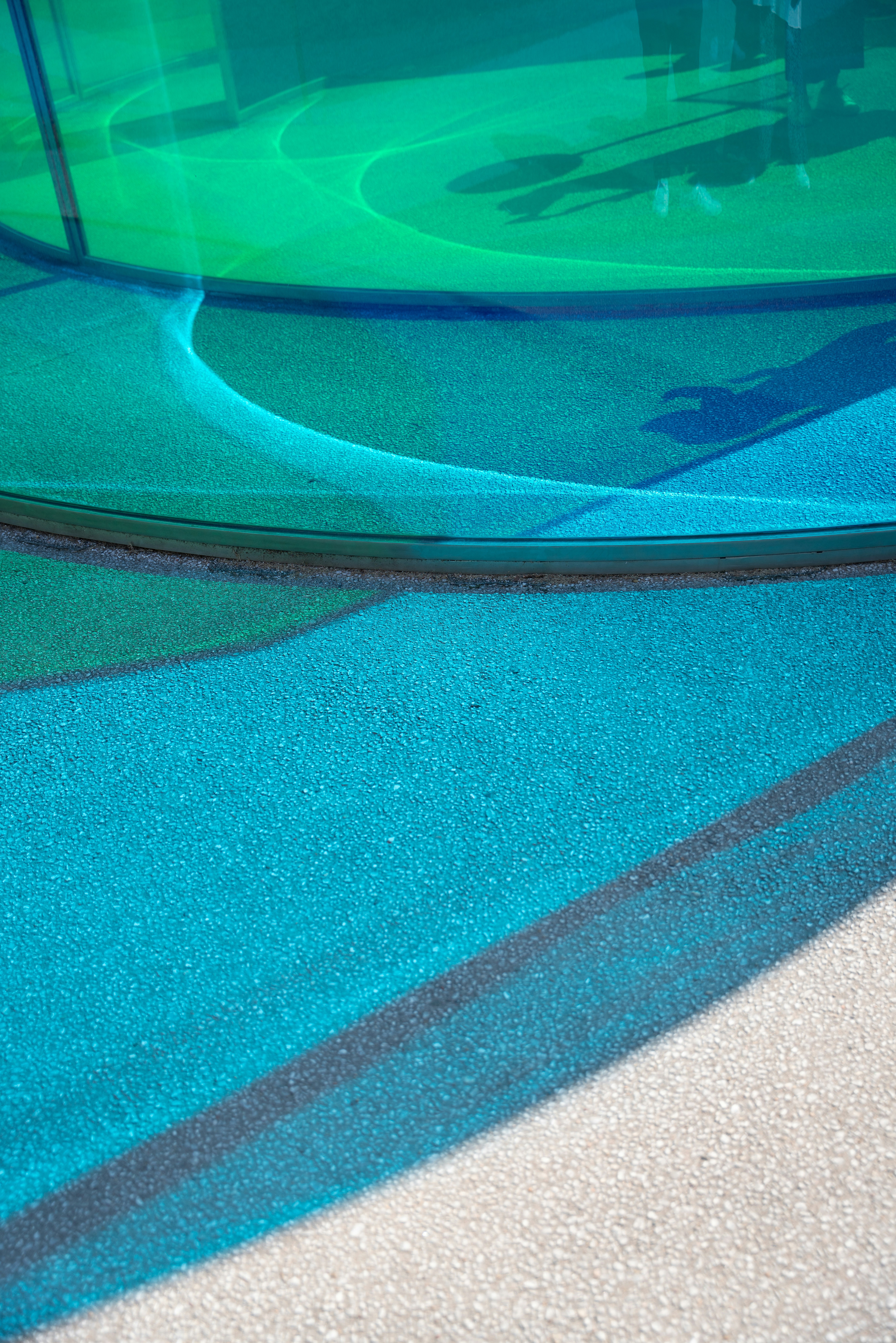 Arc of Cyan: Reflections on a Curved Glass Facade