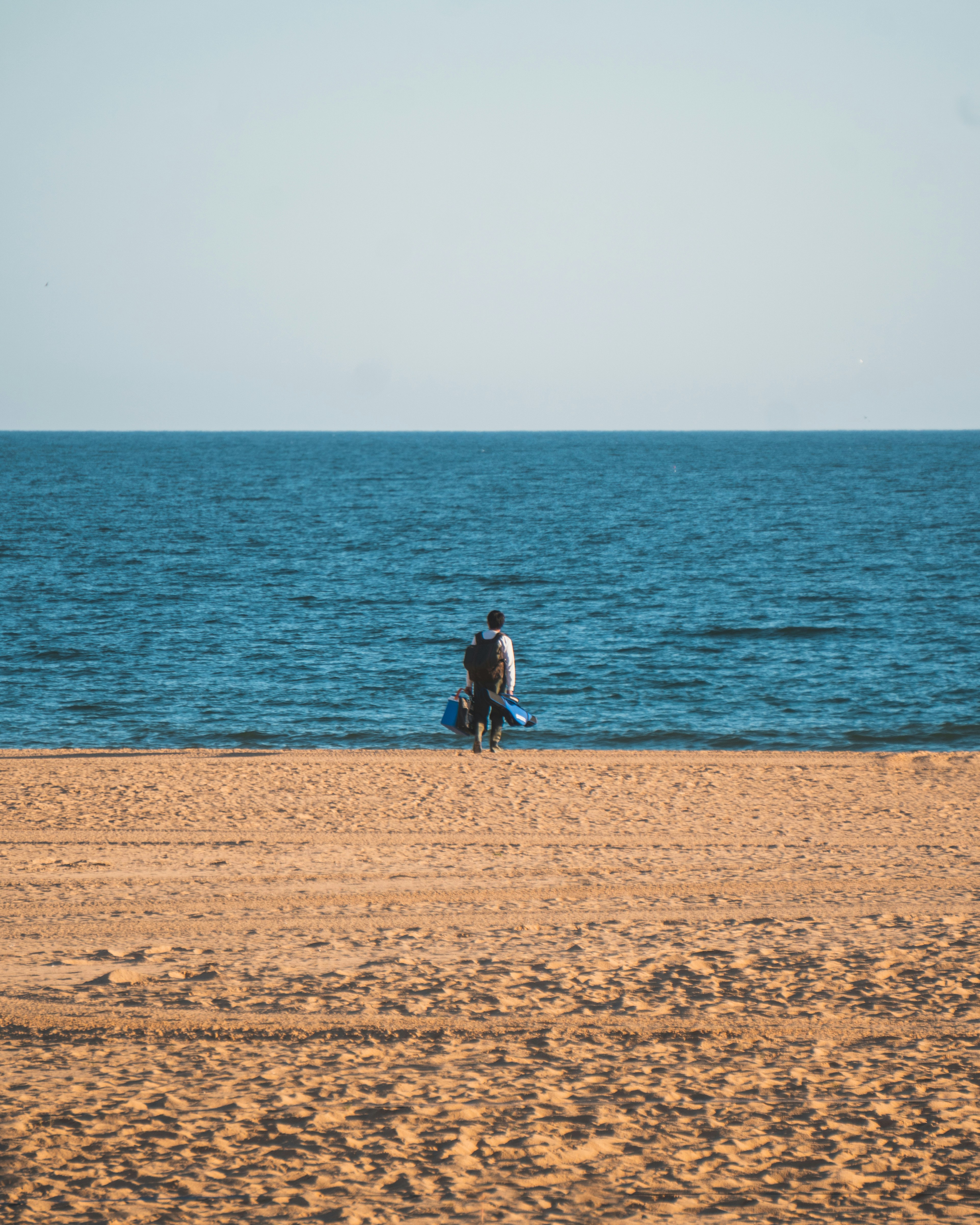 A man walking on a beach photo – Free Portimão Image on Unsplash