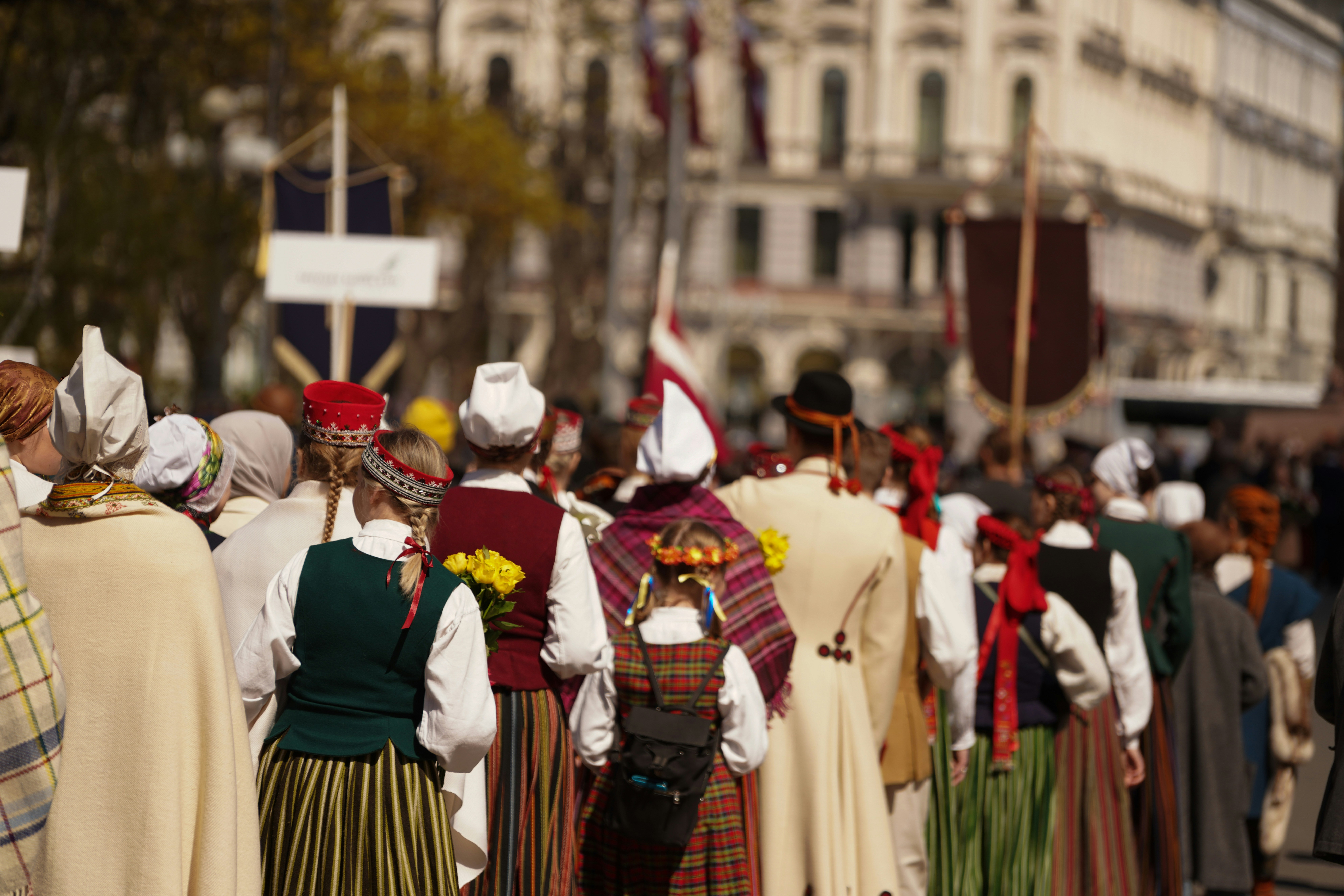 Participants in traditional attire march in a vibrant cultural procession, showcasing rich heritage and community spirit.