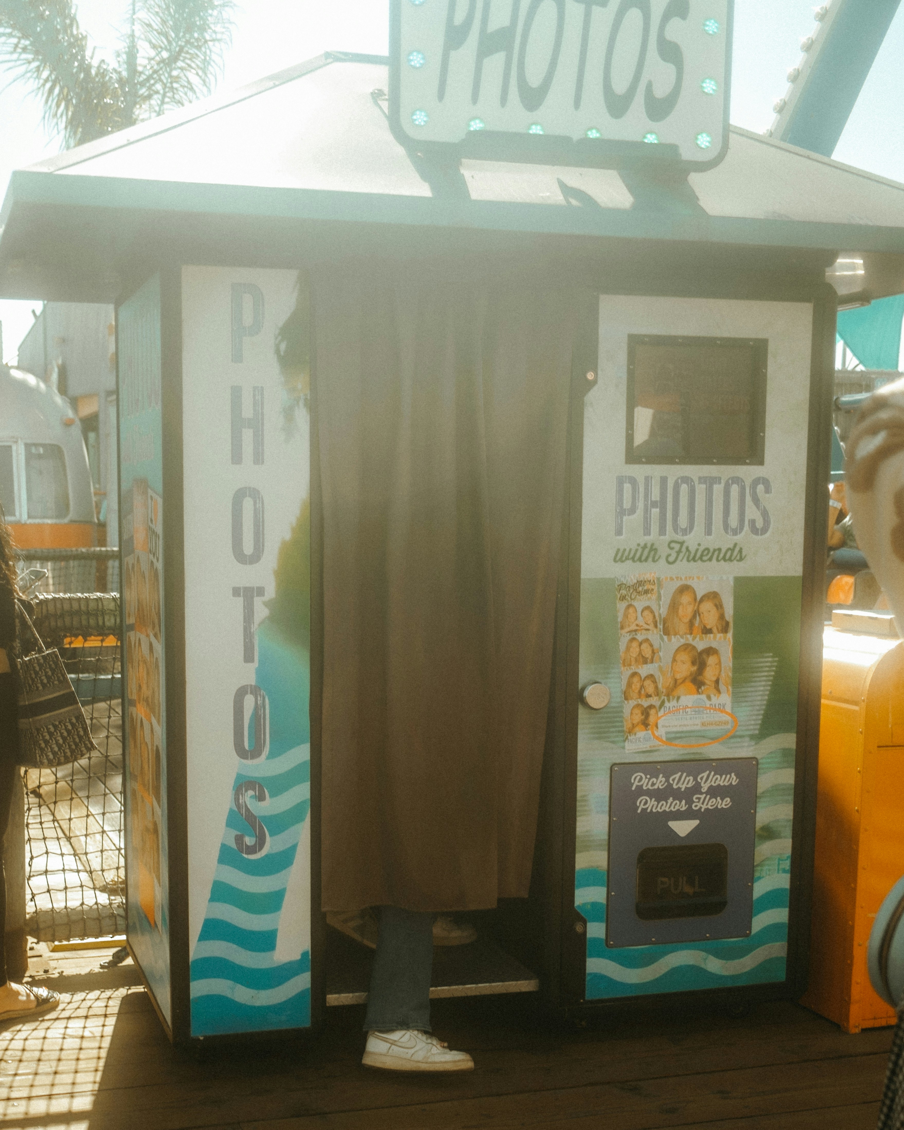 A person standing next to a sign photo – Free Santa monica pier Image ...