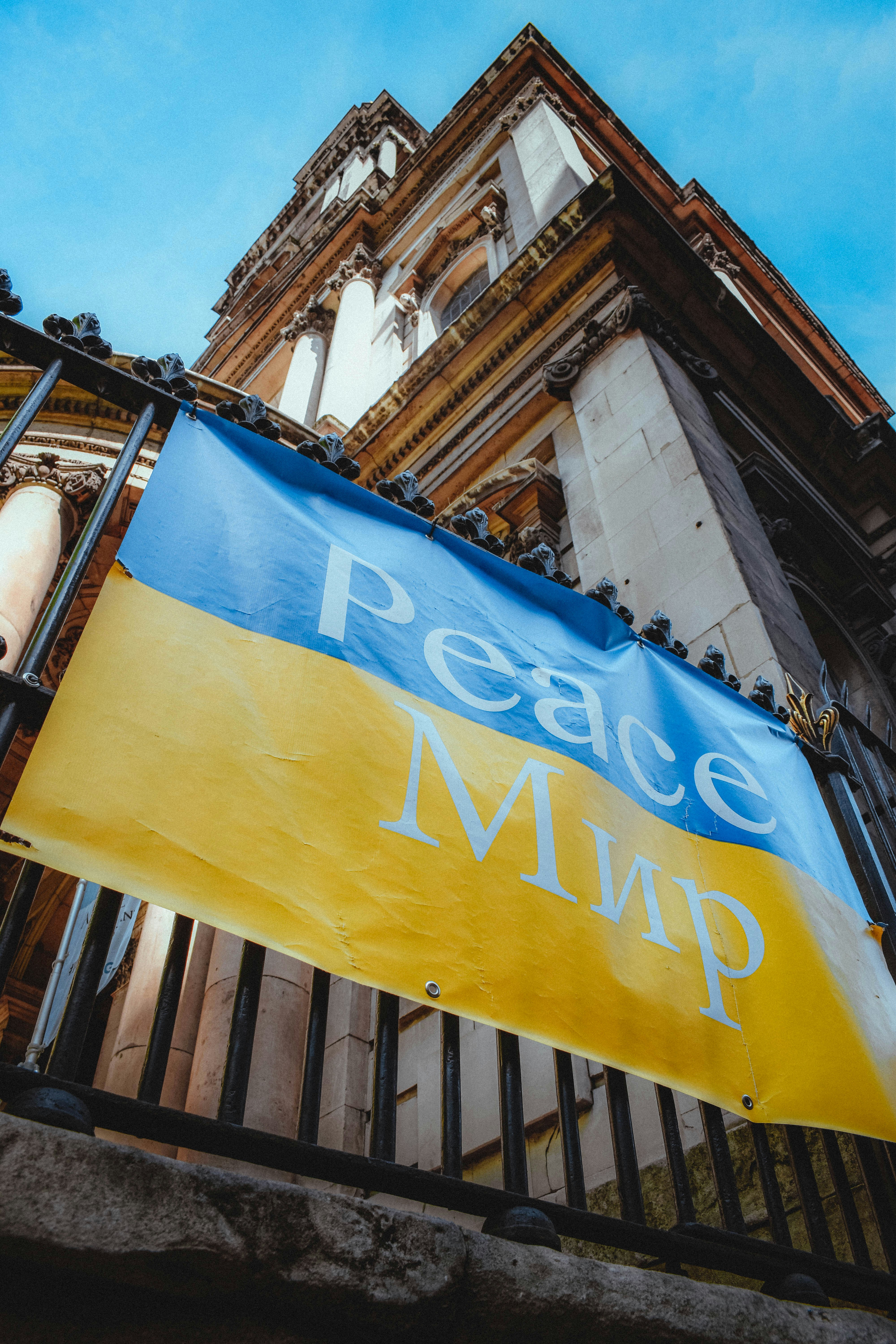 Banner of Peace: A Flag Draped Across a Historic Gate
