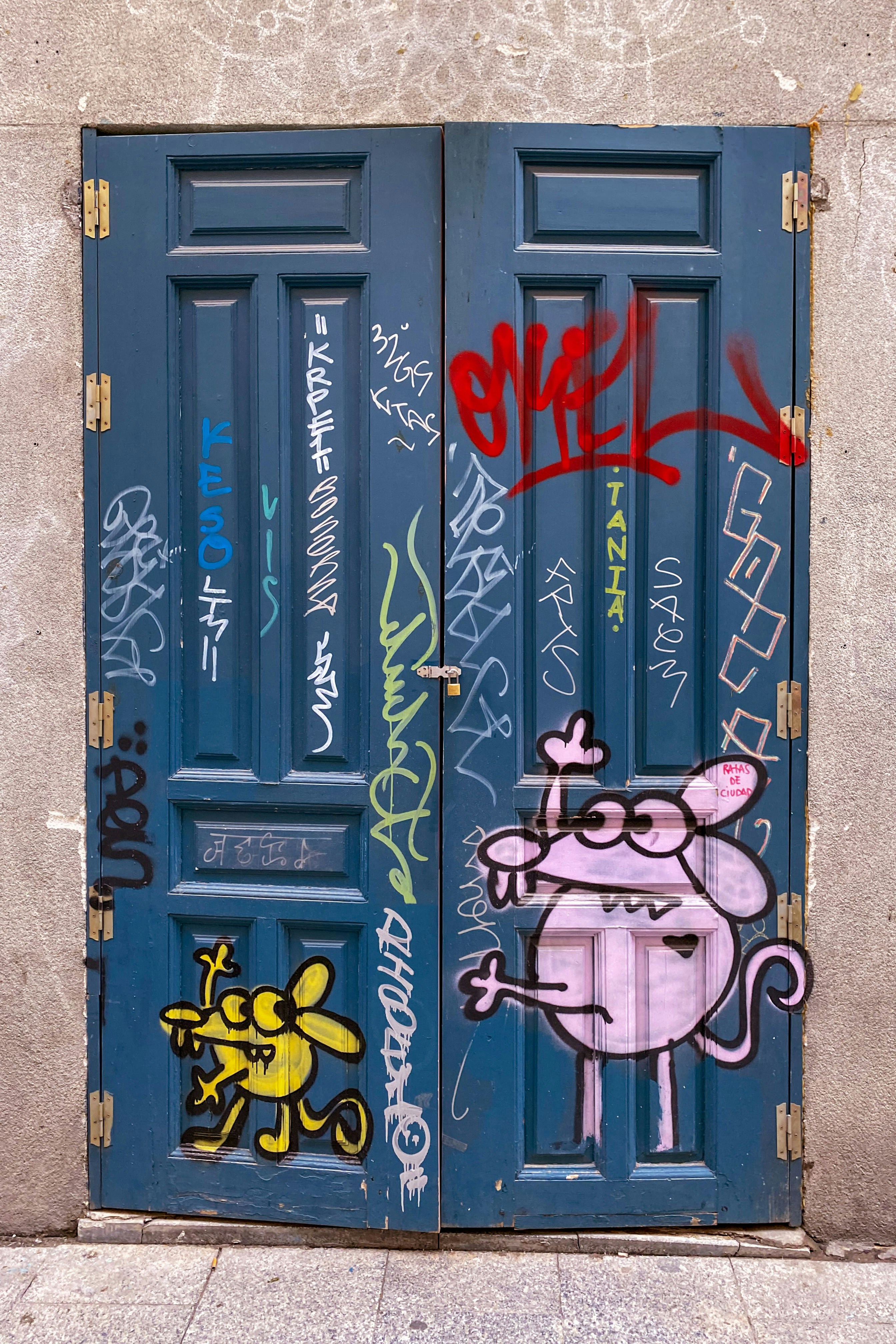 Blue Door Graffiti Duo: Pink Hippo and Yellow Pup Animate a City-Corner Panel