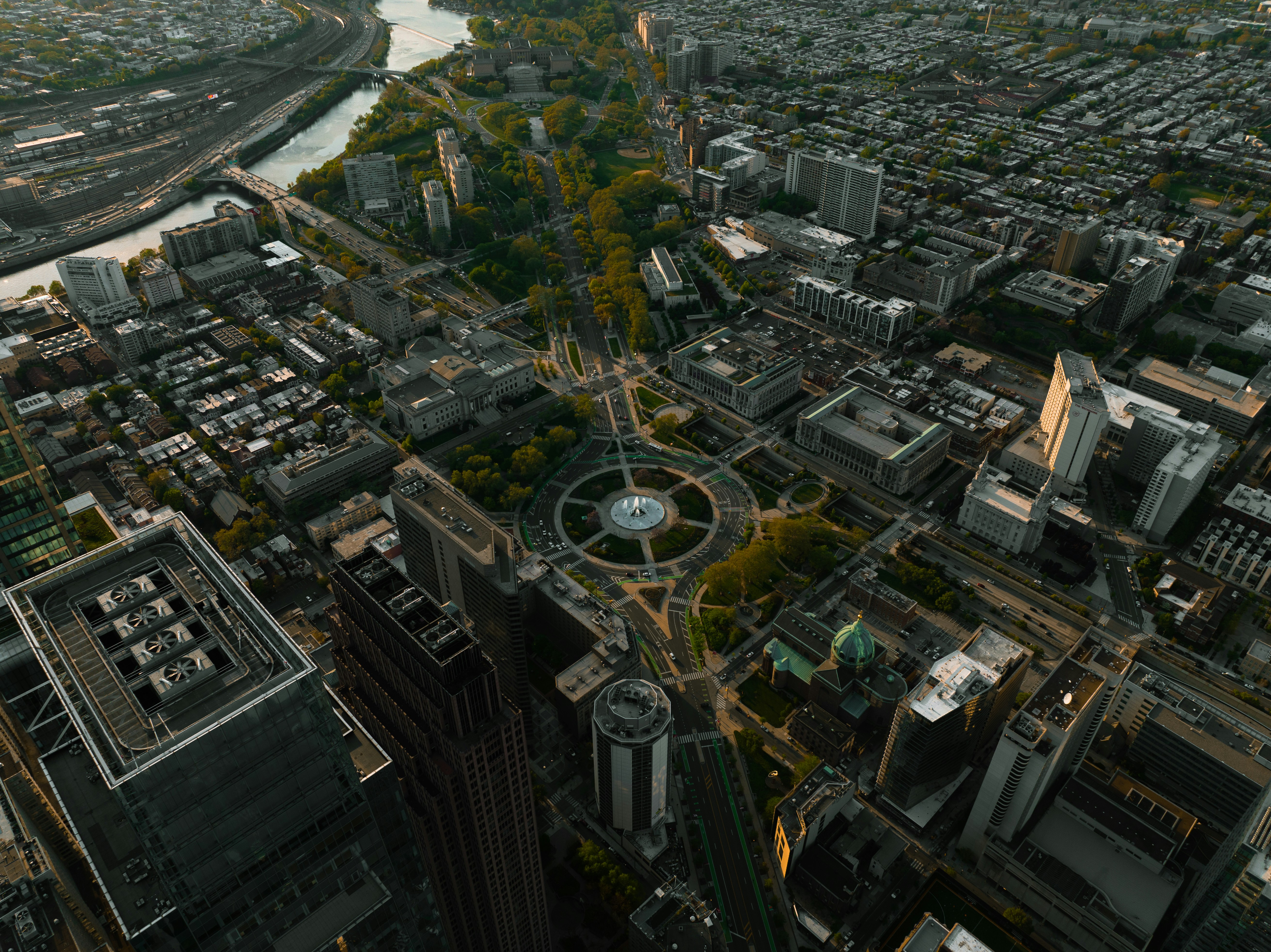 Urban Ring: Aerial view of a tree-lined central plaza encircled by skyscrapers