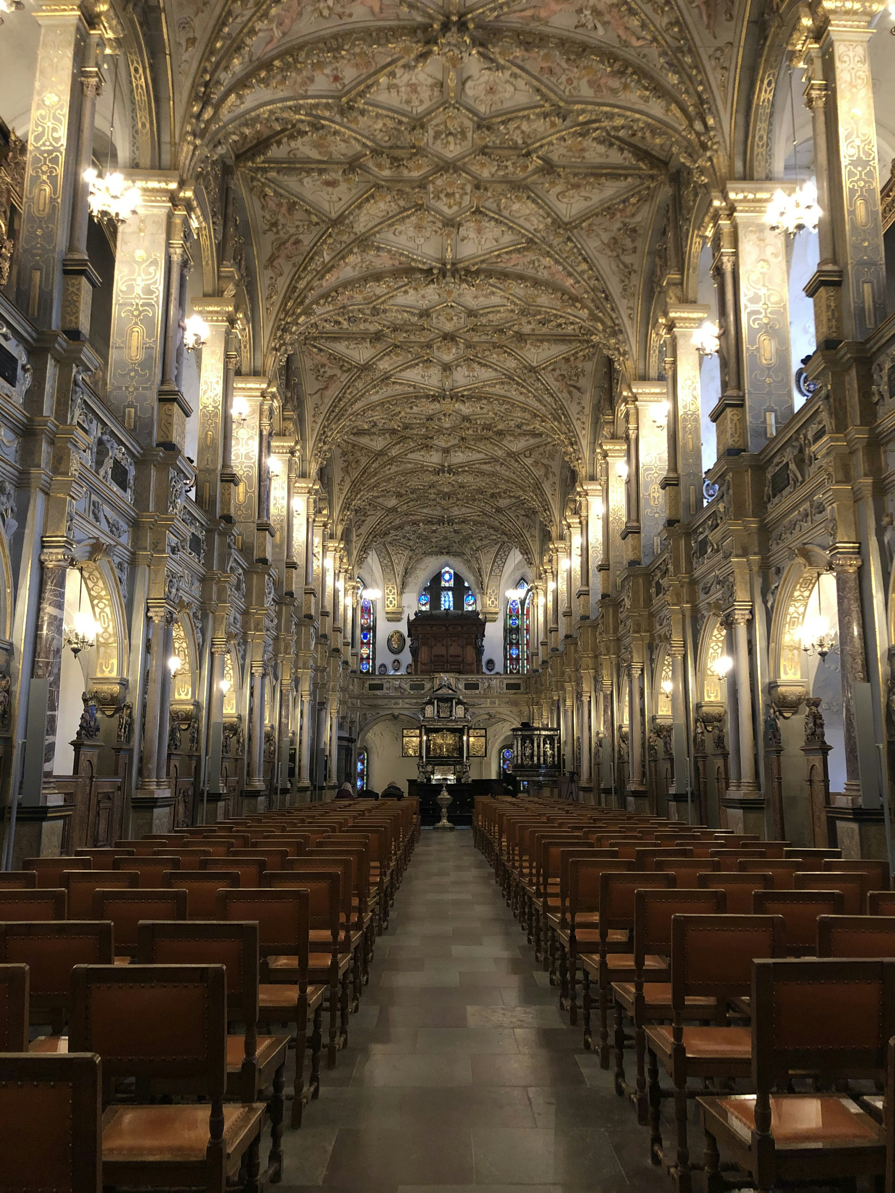 A large cathedral with rows of pews and a large chandelier photo – Free ...