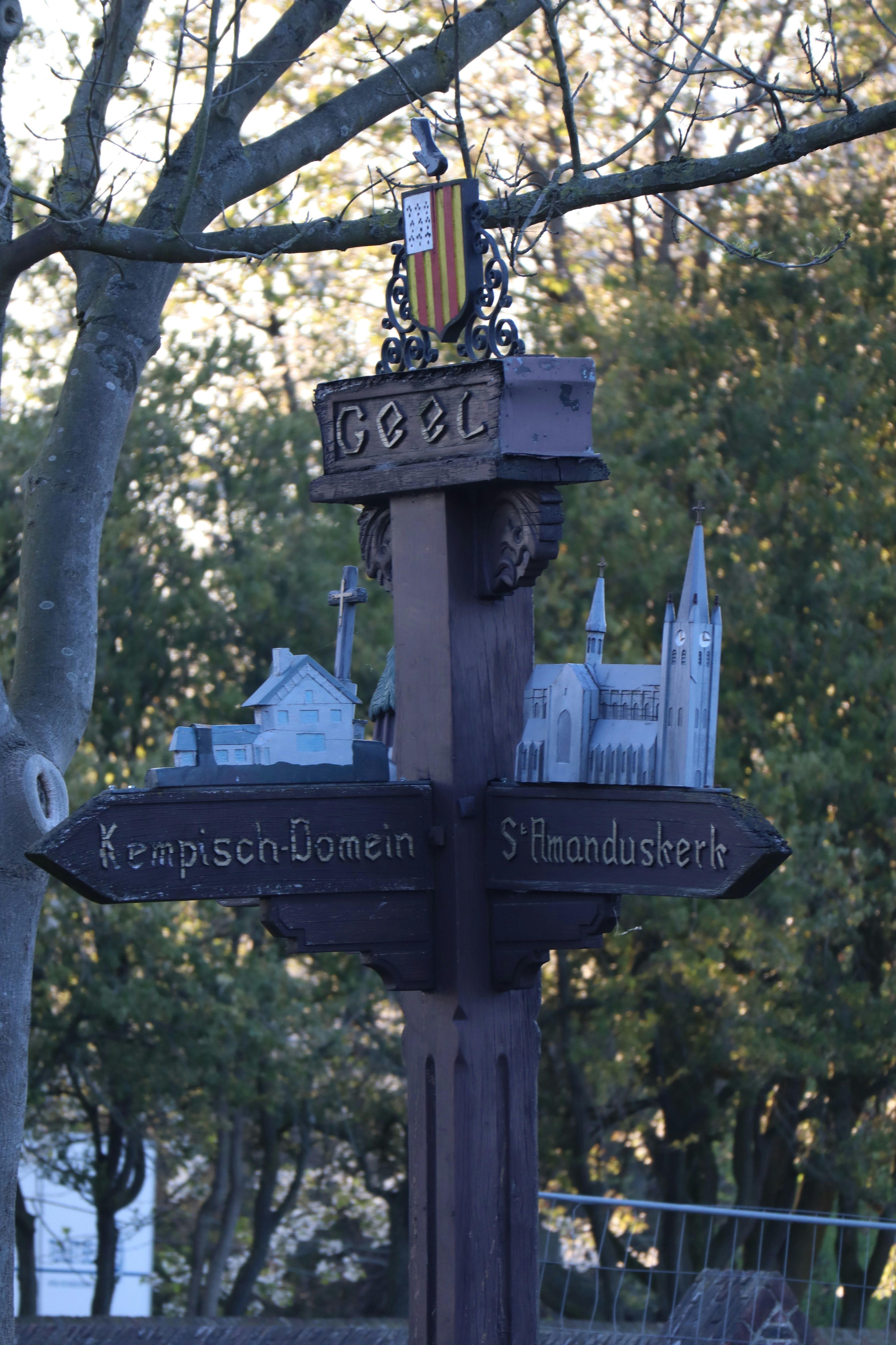 Miniature Church Cartography: A Weathered Signpost in a Quiet Park