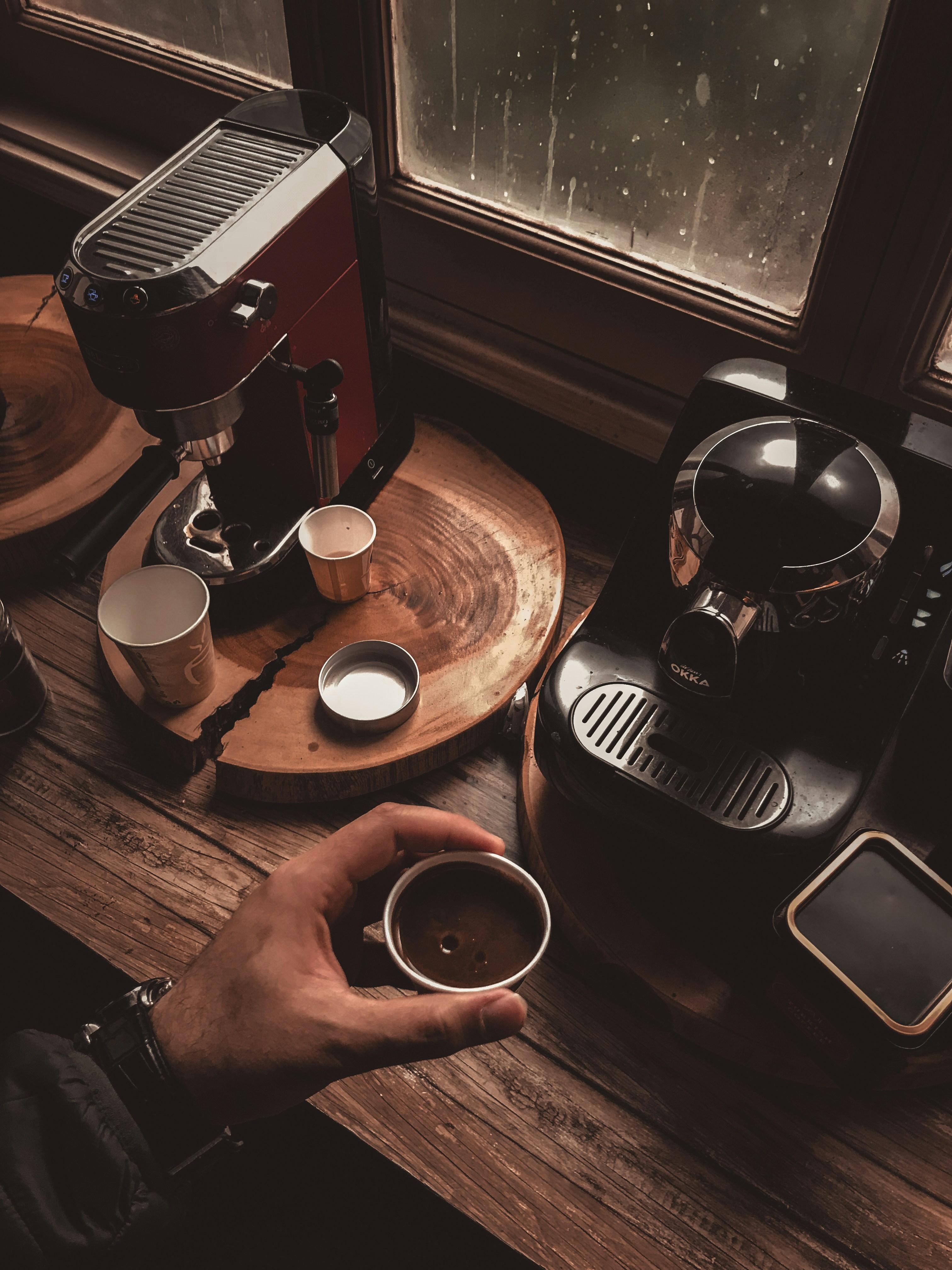 Crema in Hand: A Dimly Lit Ritual Among Coffee Machinery