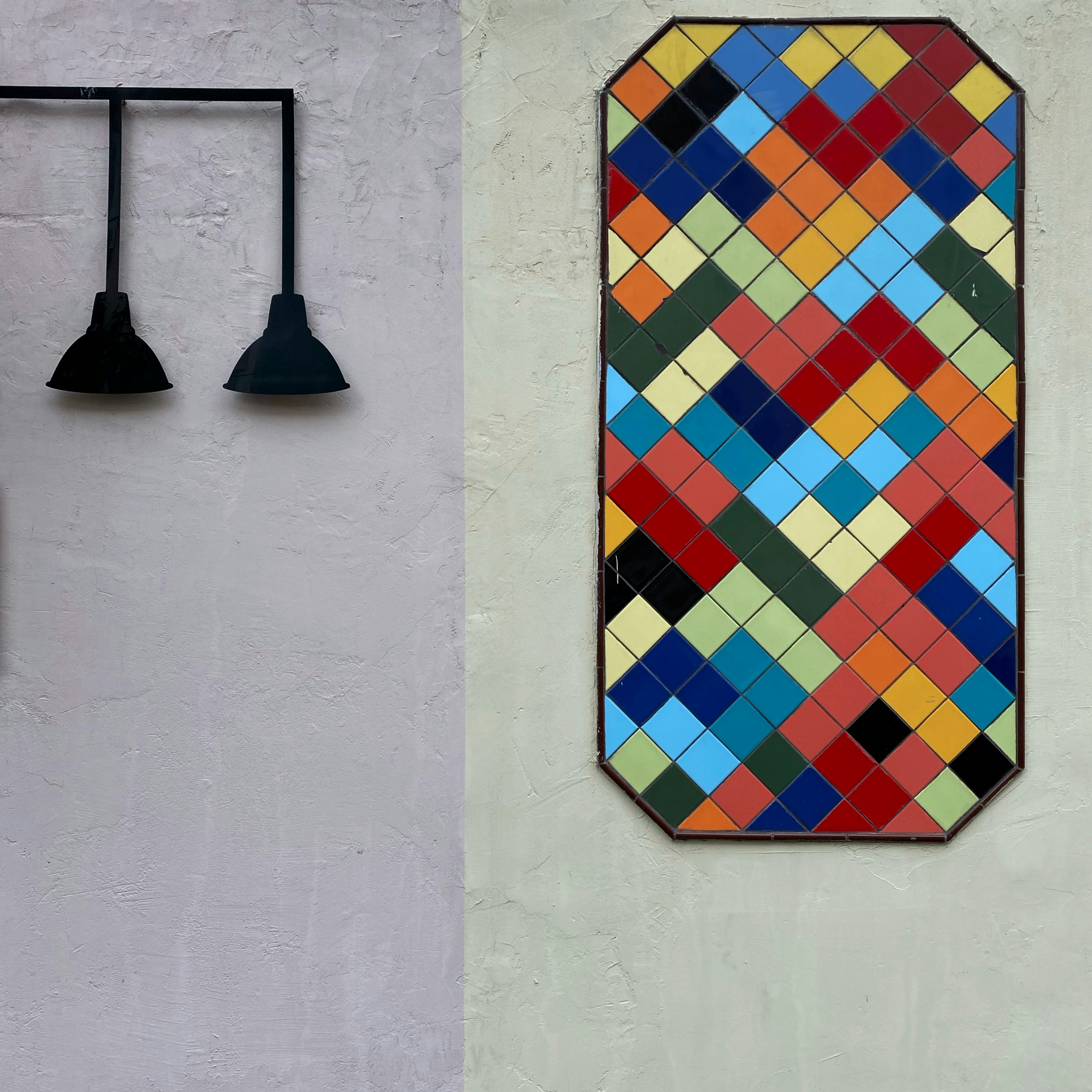 Patchwork Portal: A Colorful Diamond Mosaic on a Quiet Facade